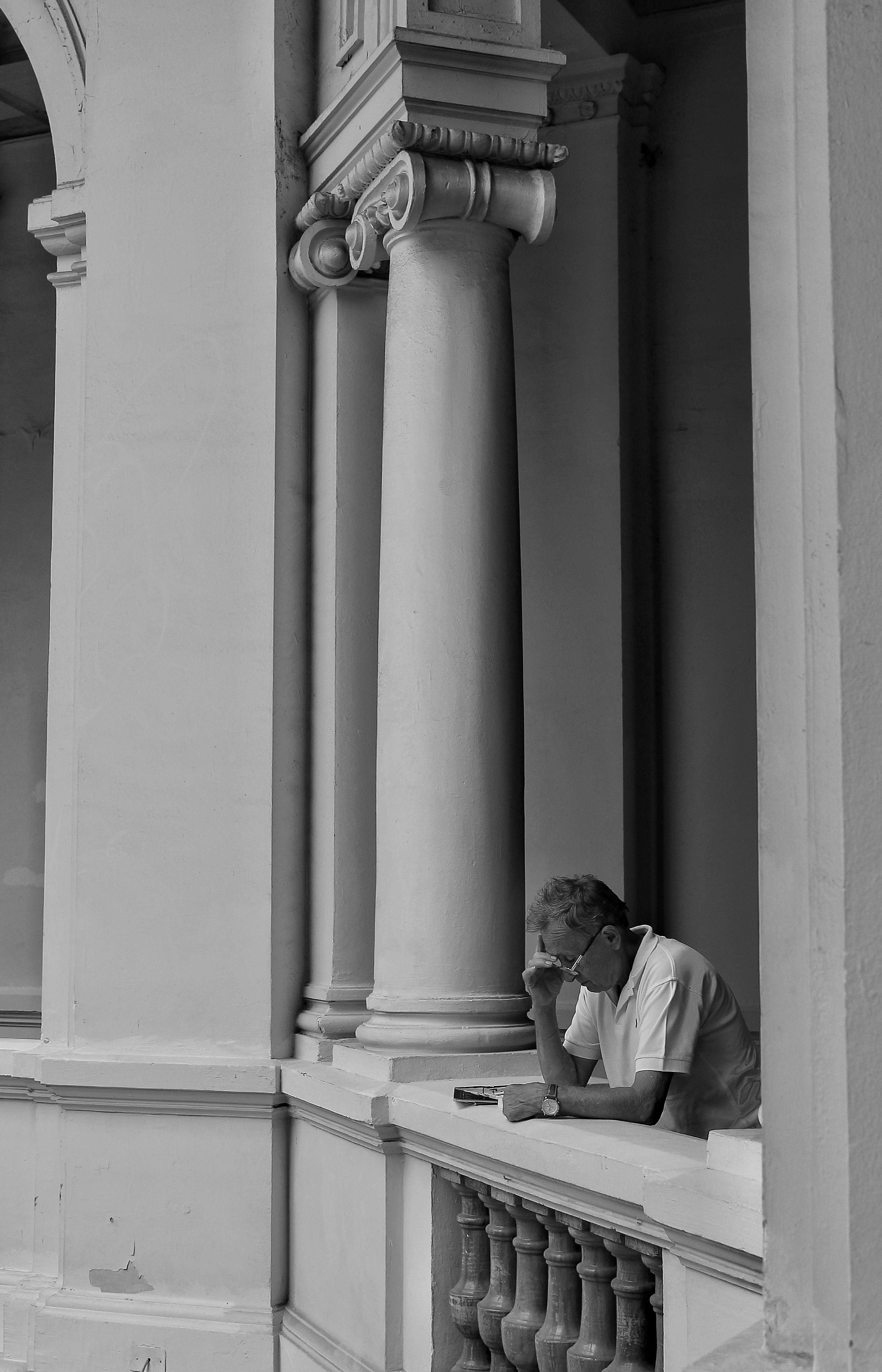 A Man Leaning on the Balcony · Free Stock Photo