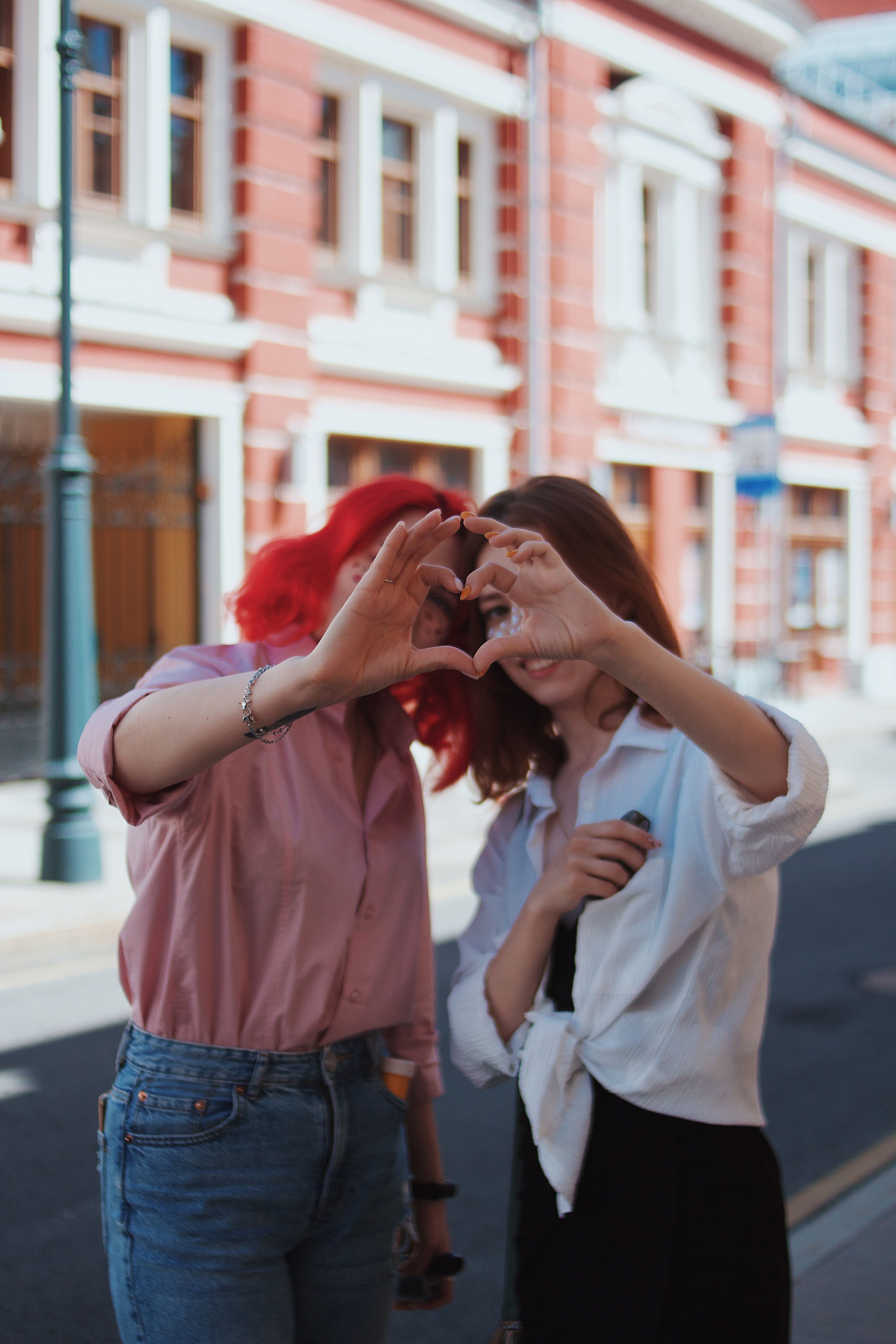 Women Doing a Heart Hand Sign · Free Stock Photo