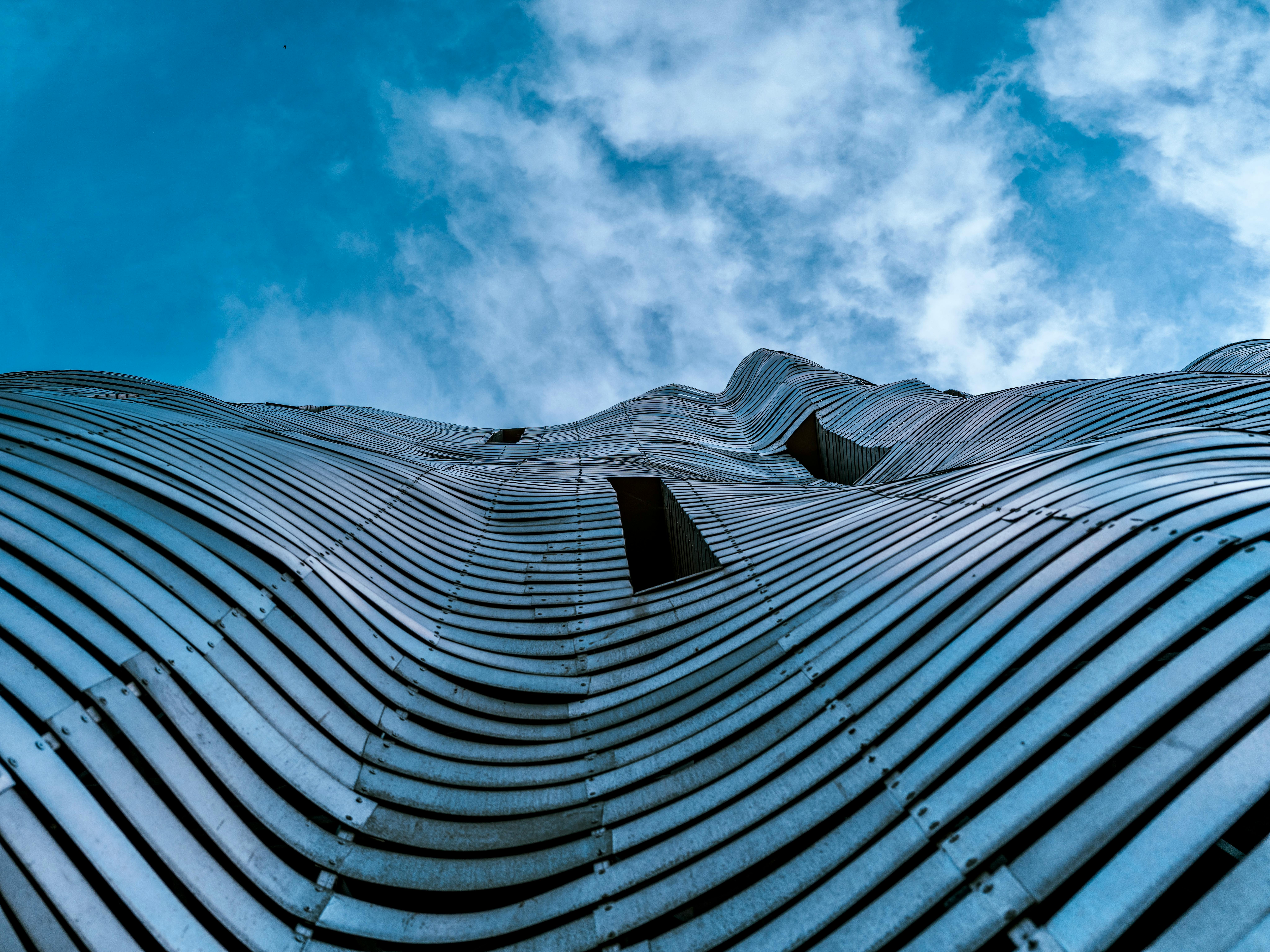 Low Angle Shot of a Steel Structure Under White Clouds · Free Stock Photo