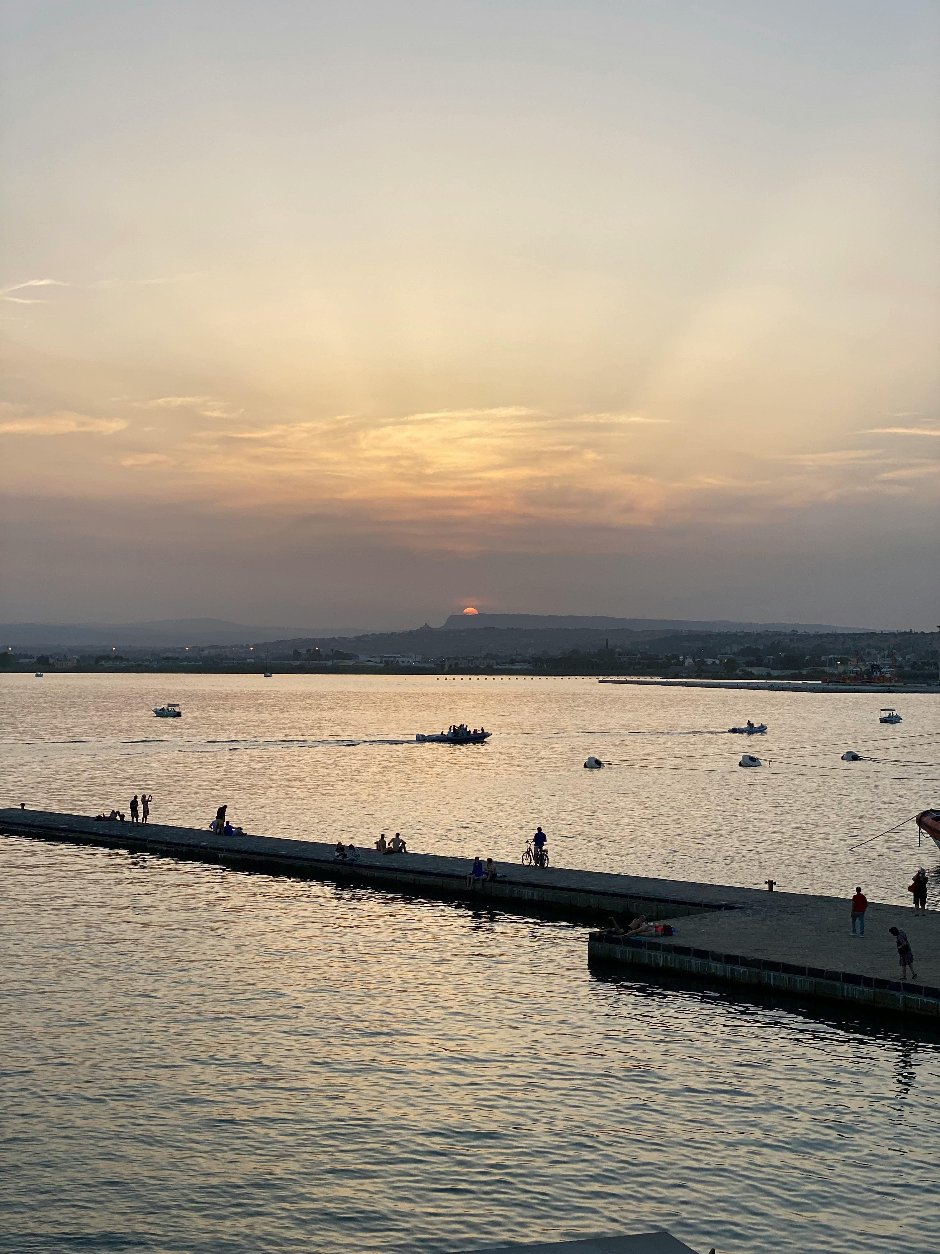 People Watching Sunset near Water · Free Stock Photo