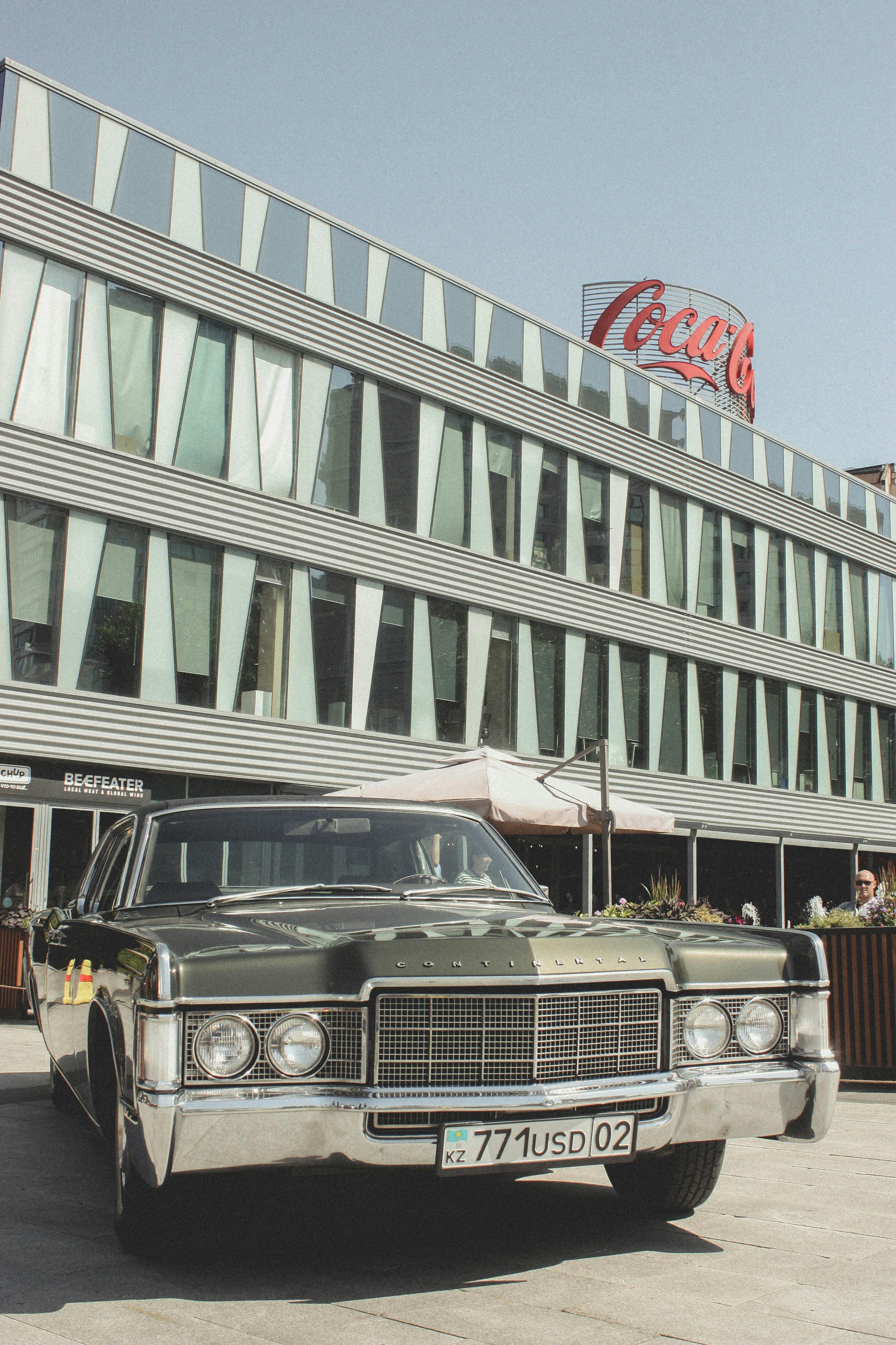 Vintage Car Parked Beside a Building · Free Stock Photo