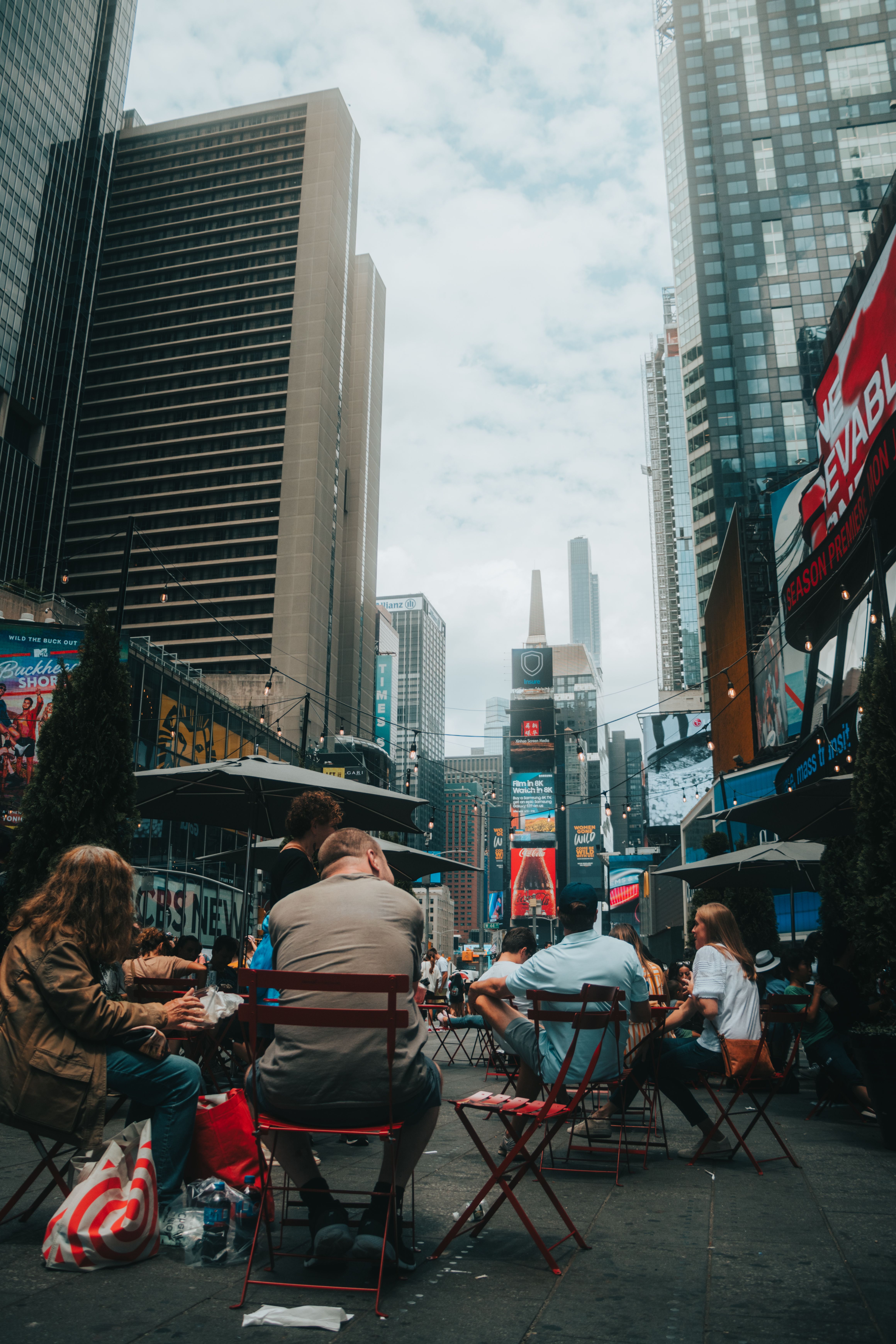 People Sitting by Tables of Street Food Stalls in City · Free Stock Photo