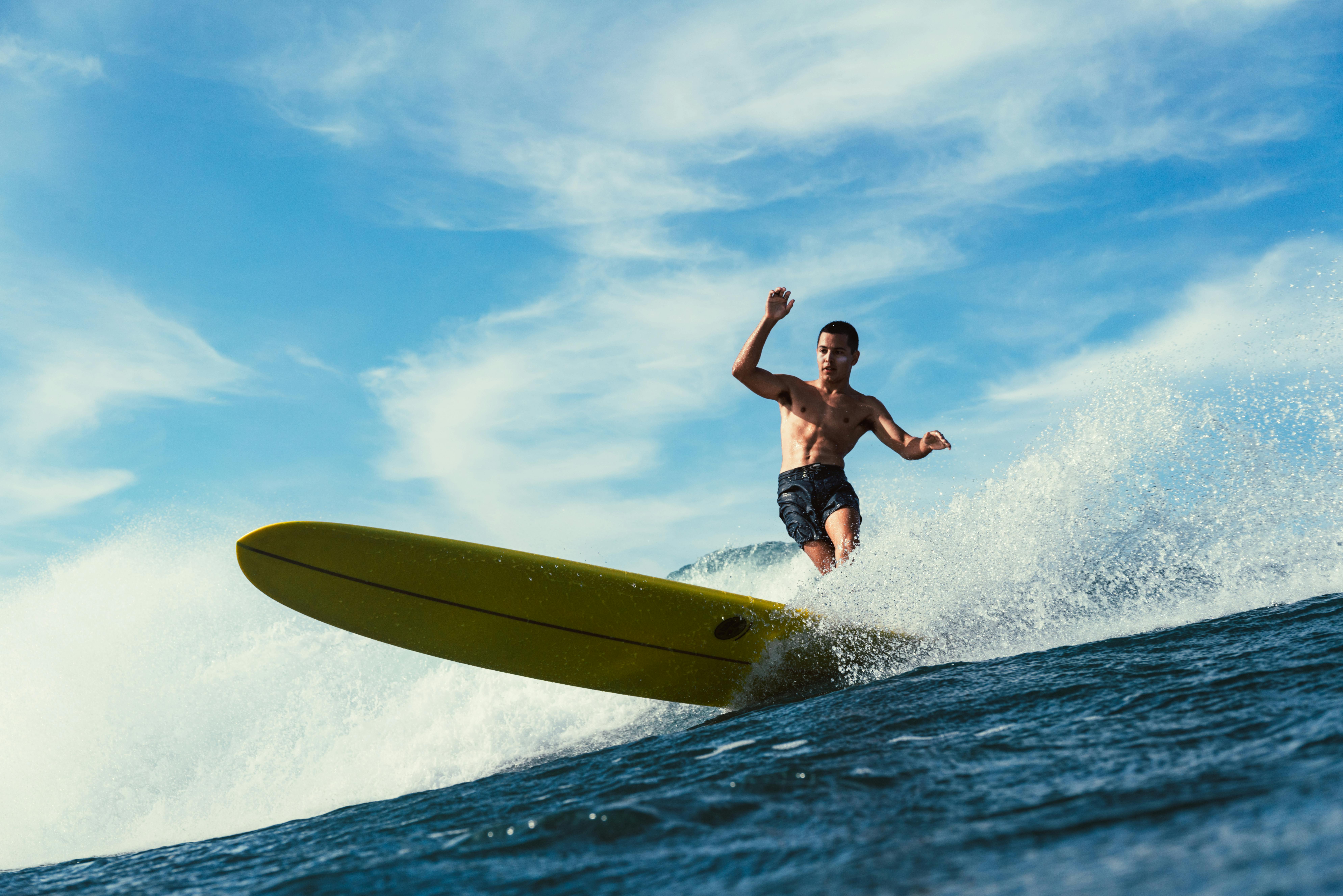 Low Angle Shot of a Man Surfing · Free Stock Photo