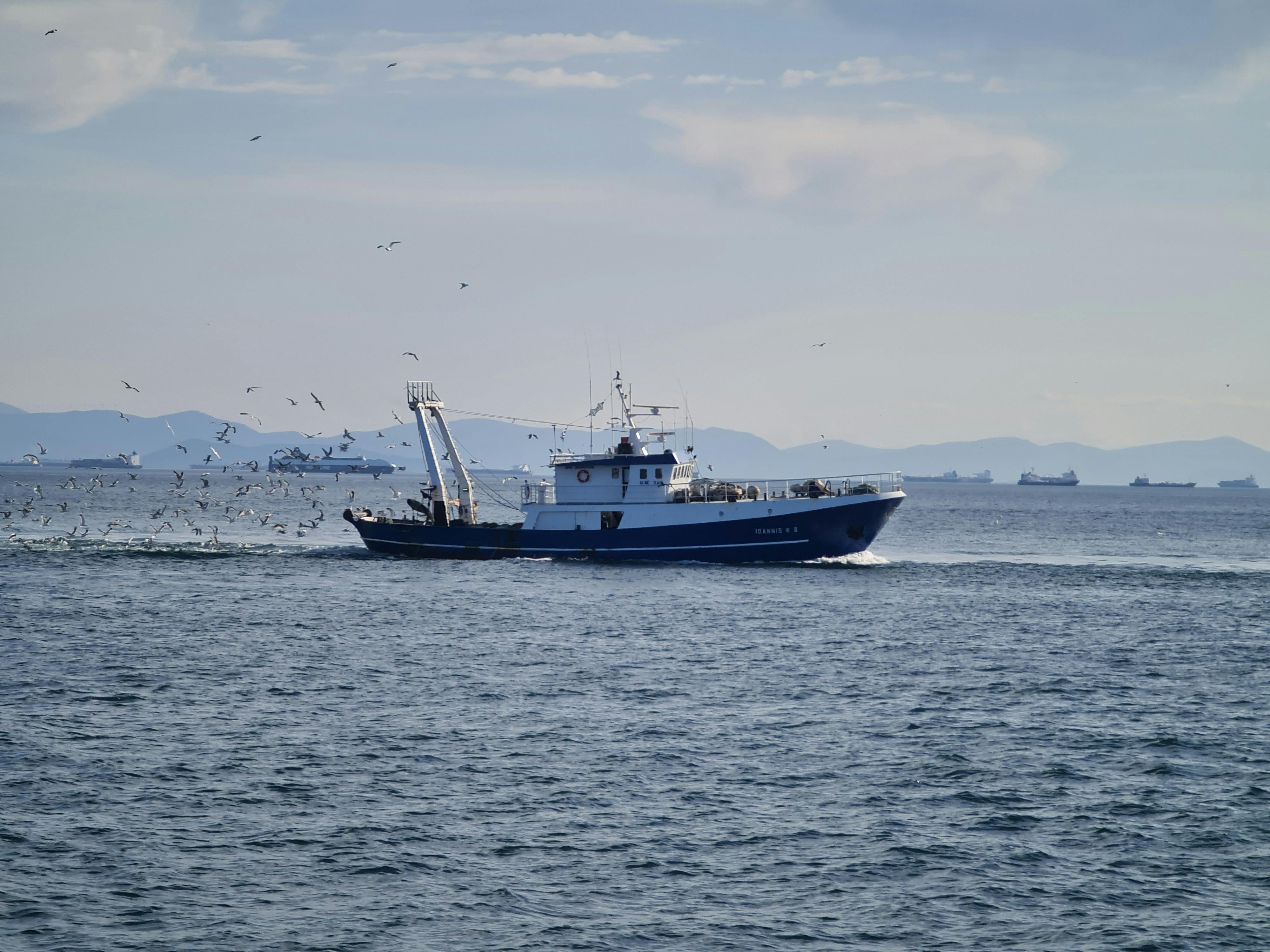 Fishing Boat Traveling Across The Sea · Free Stock Photo