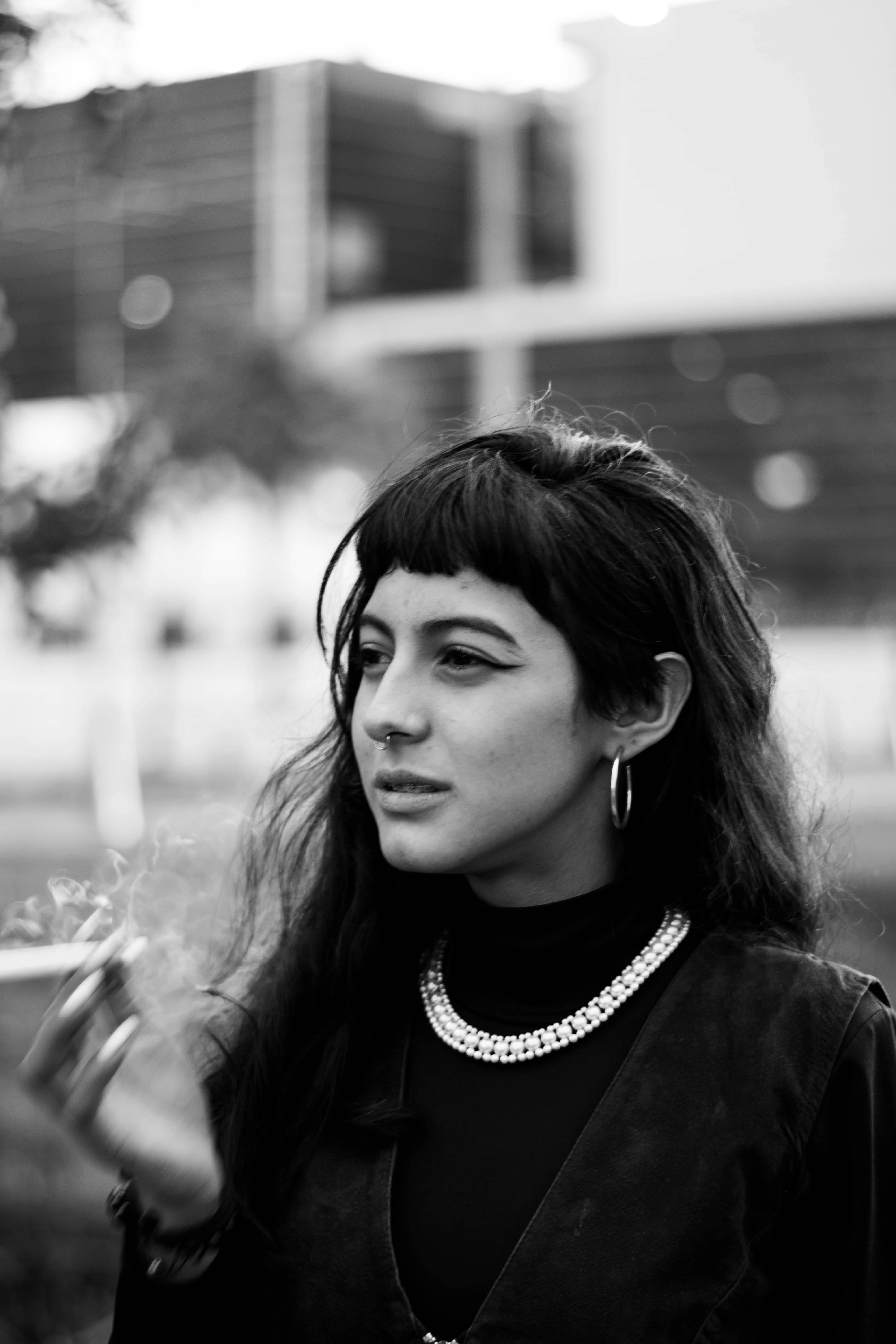 Woman Crouching Among Balloons and Smoking a Cigarette with her Head ...