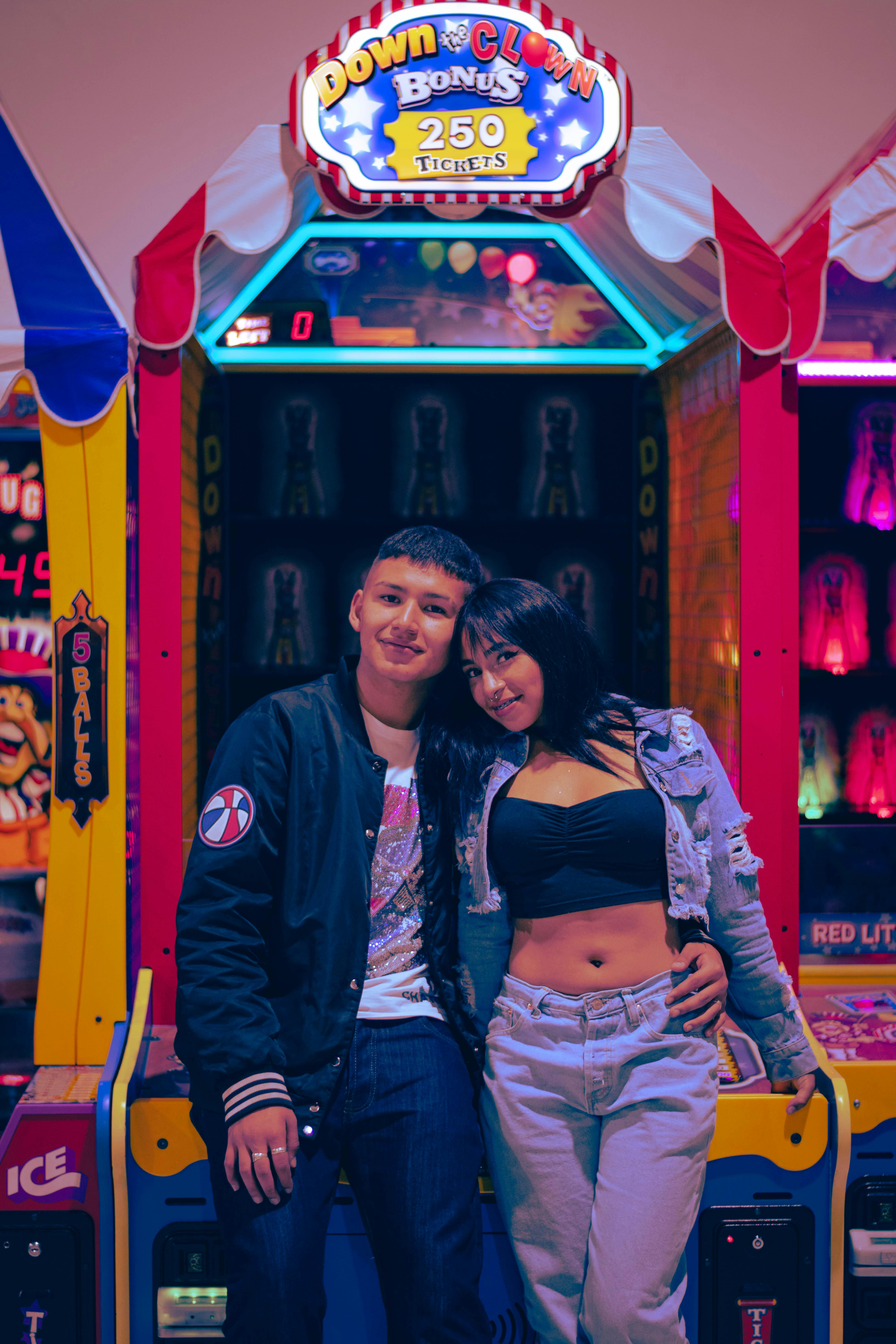 Young Couple Hugging in an Arcade · Free Stock Photo