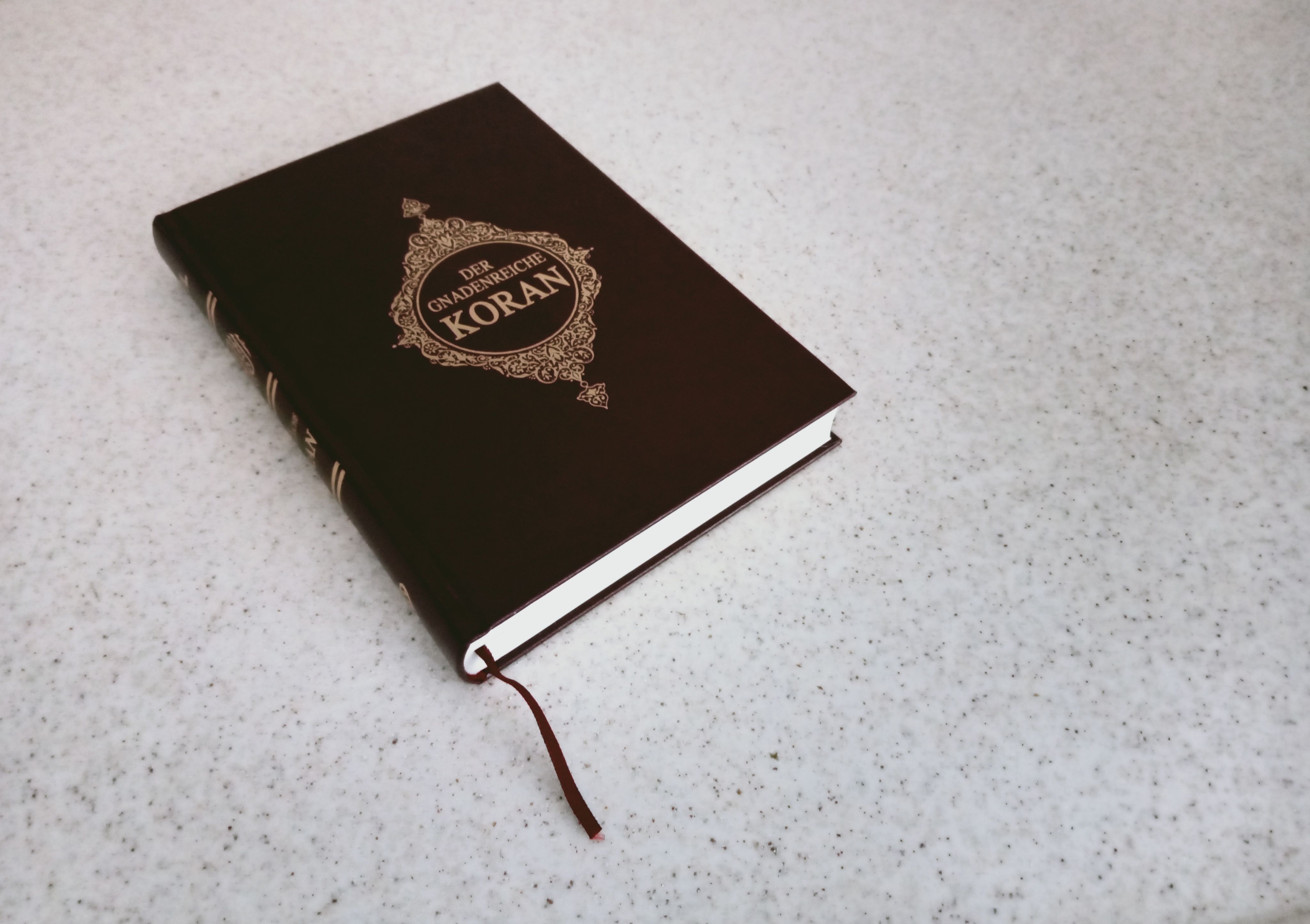 An Open Koran on a Wooden Table · Free Stock Photo