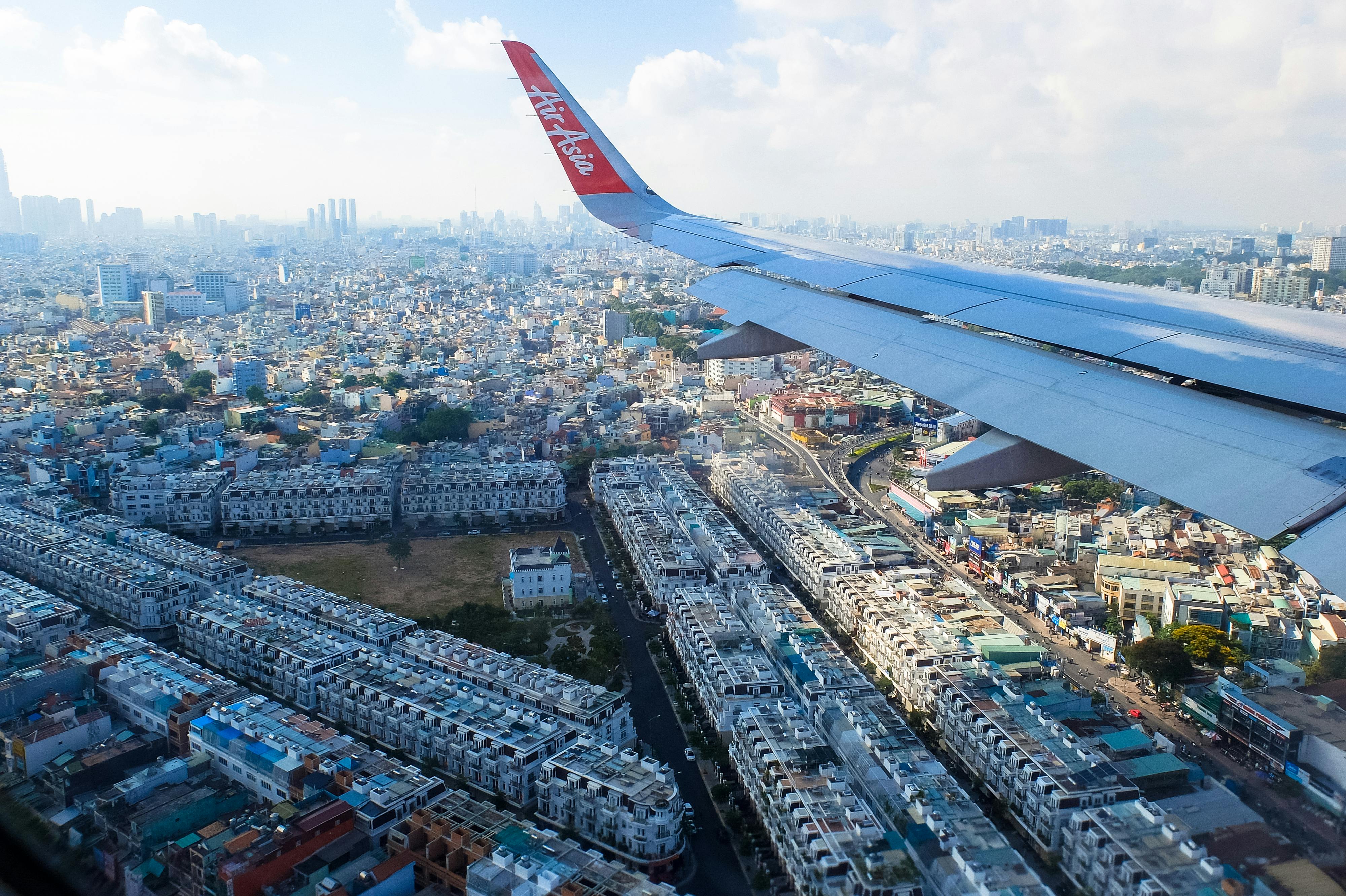 Ho Chi Minh City Through the Porthole of AirAsia Plane · Free Stock Photo