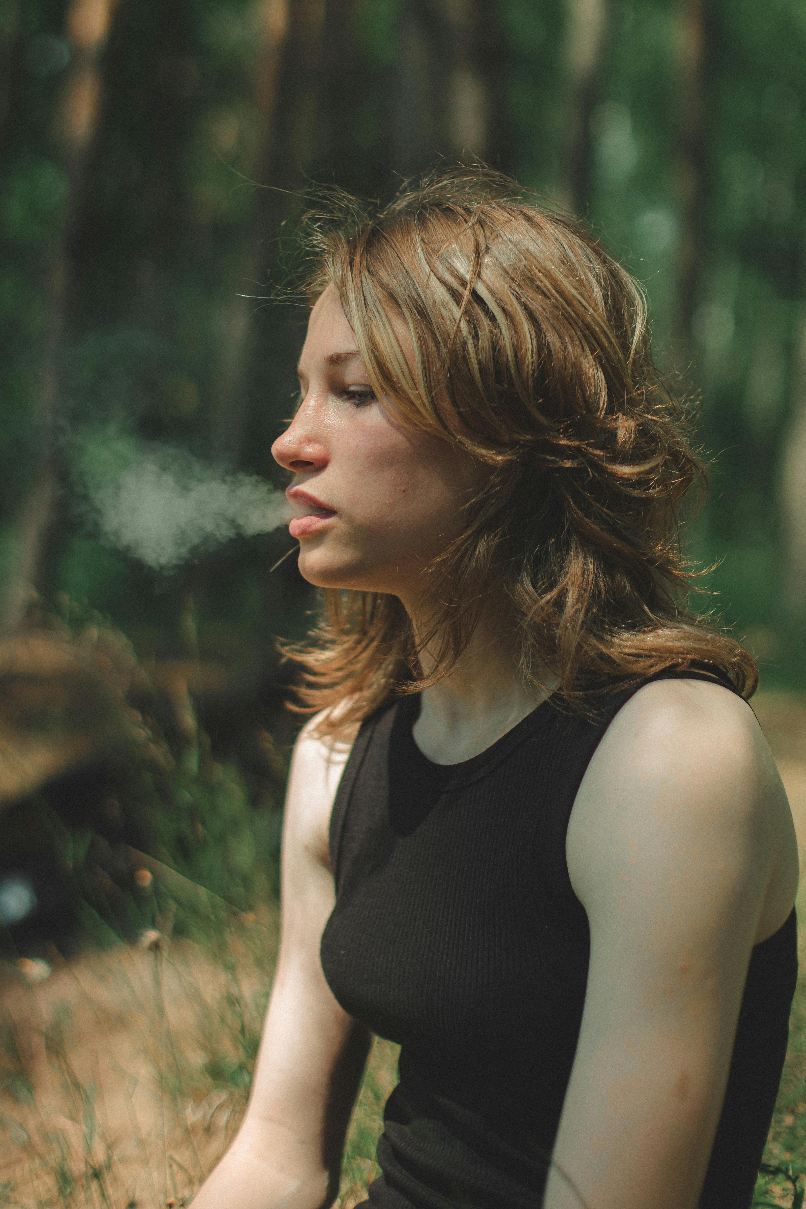 Woman in Black Tank Top Smoking · Free Stock Photo