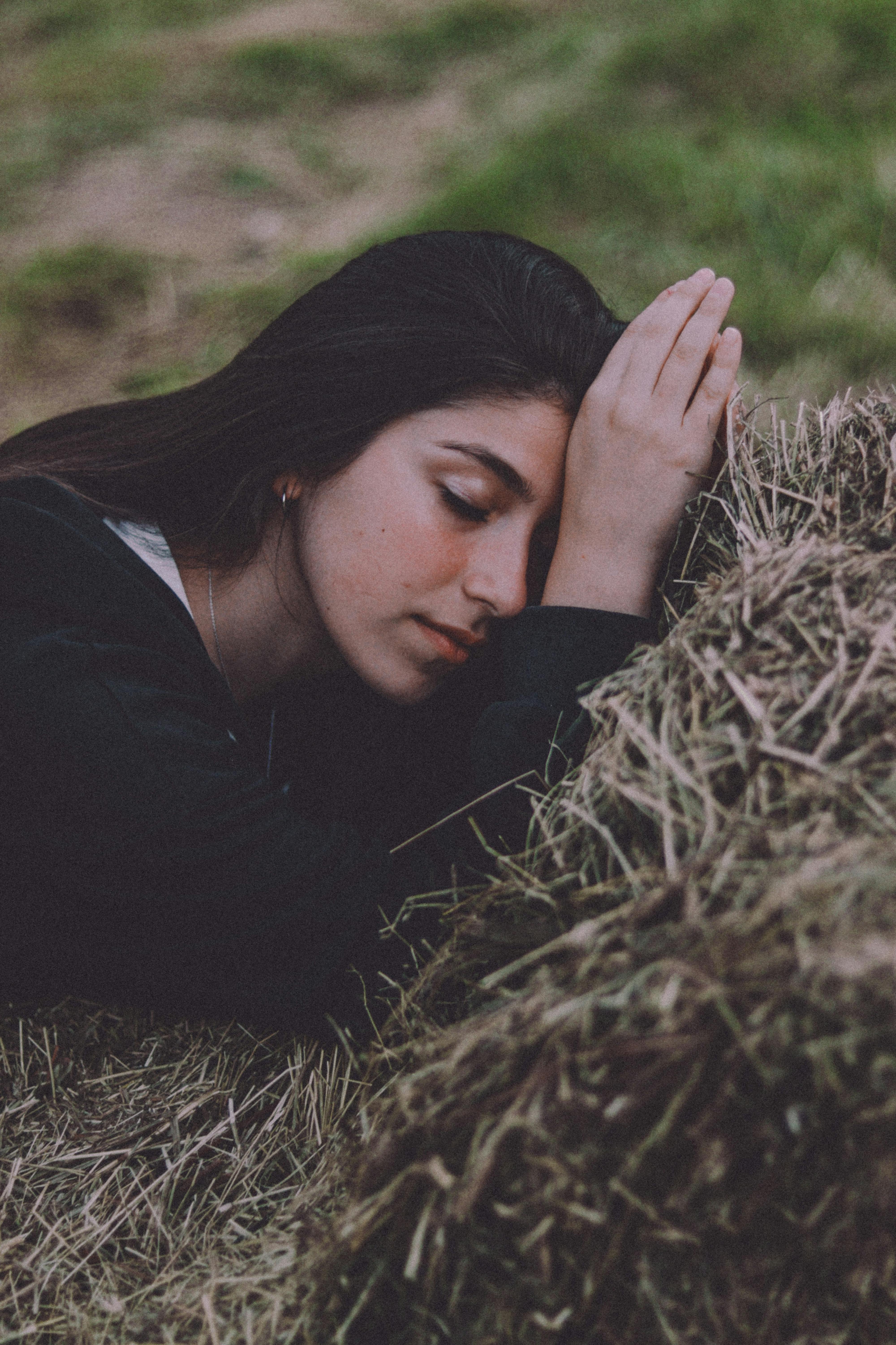 Woman Lying on Bale of Hay · Free Stock Photo