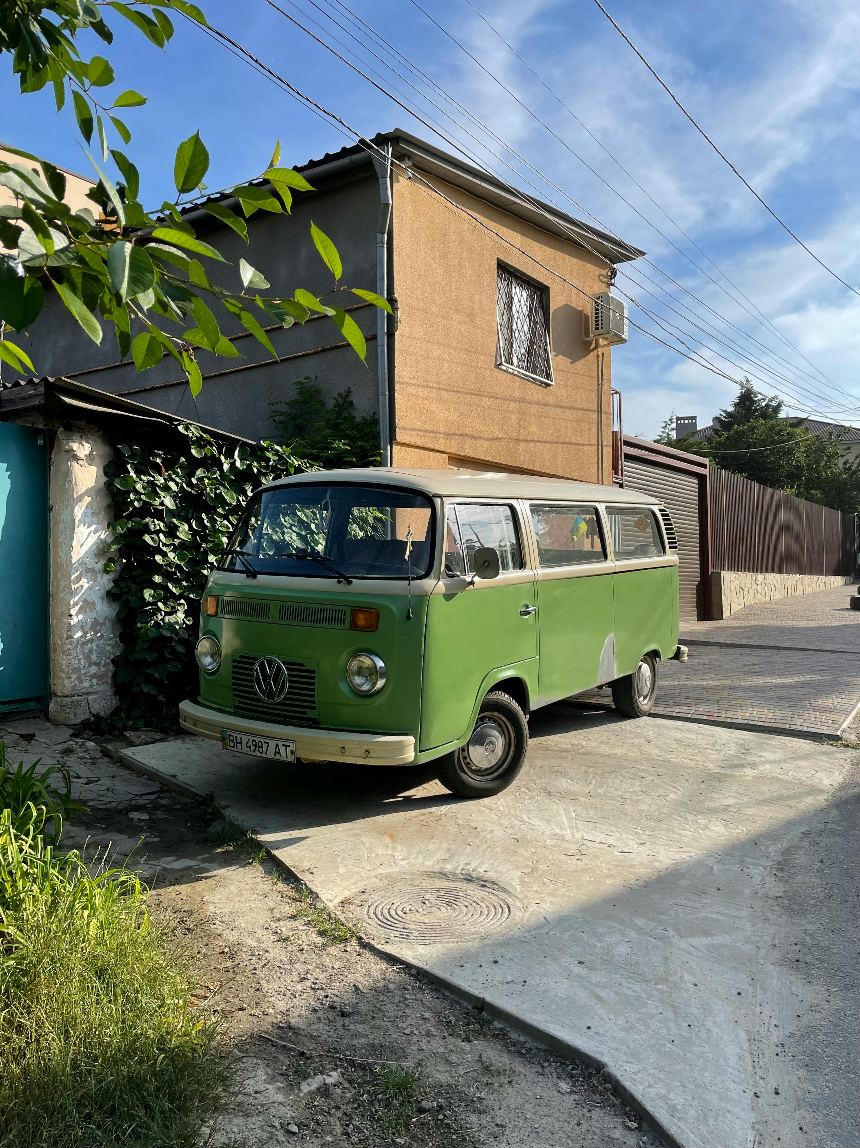 Green Volkswagen Van Parked Outside a Family House · Free Stock Photo