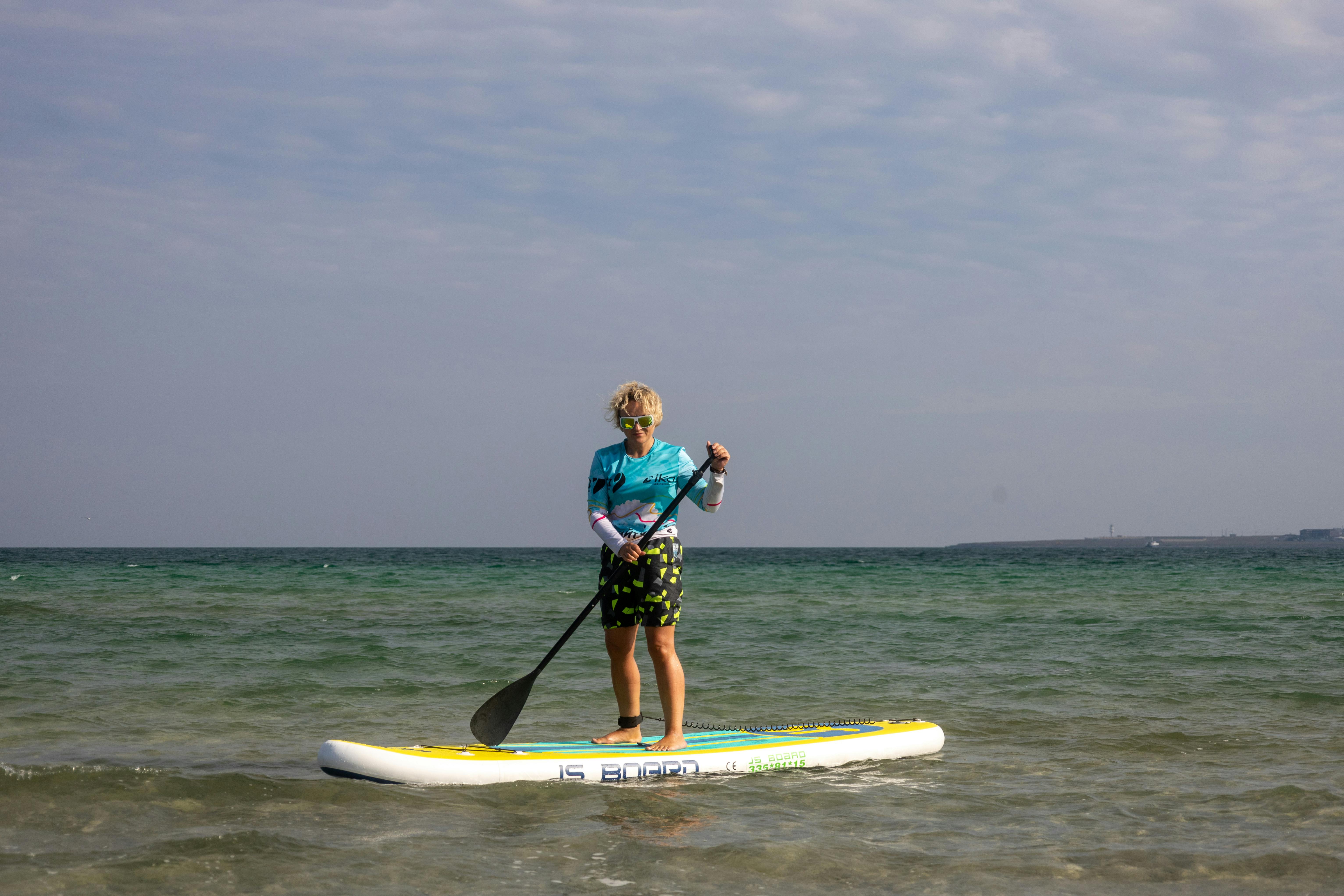 A Woman using a Paddleboard · Free Stock Photo
