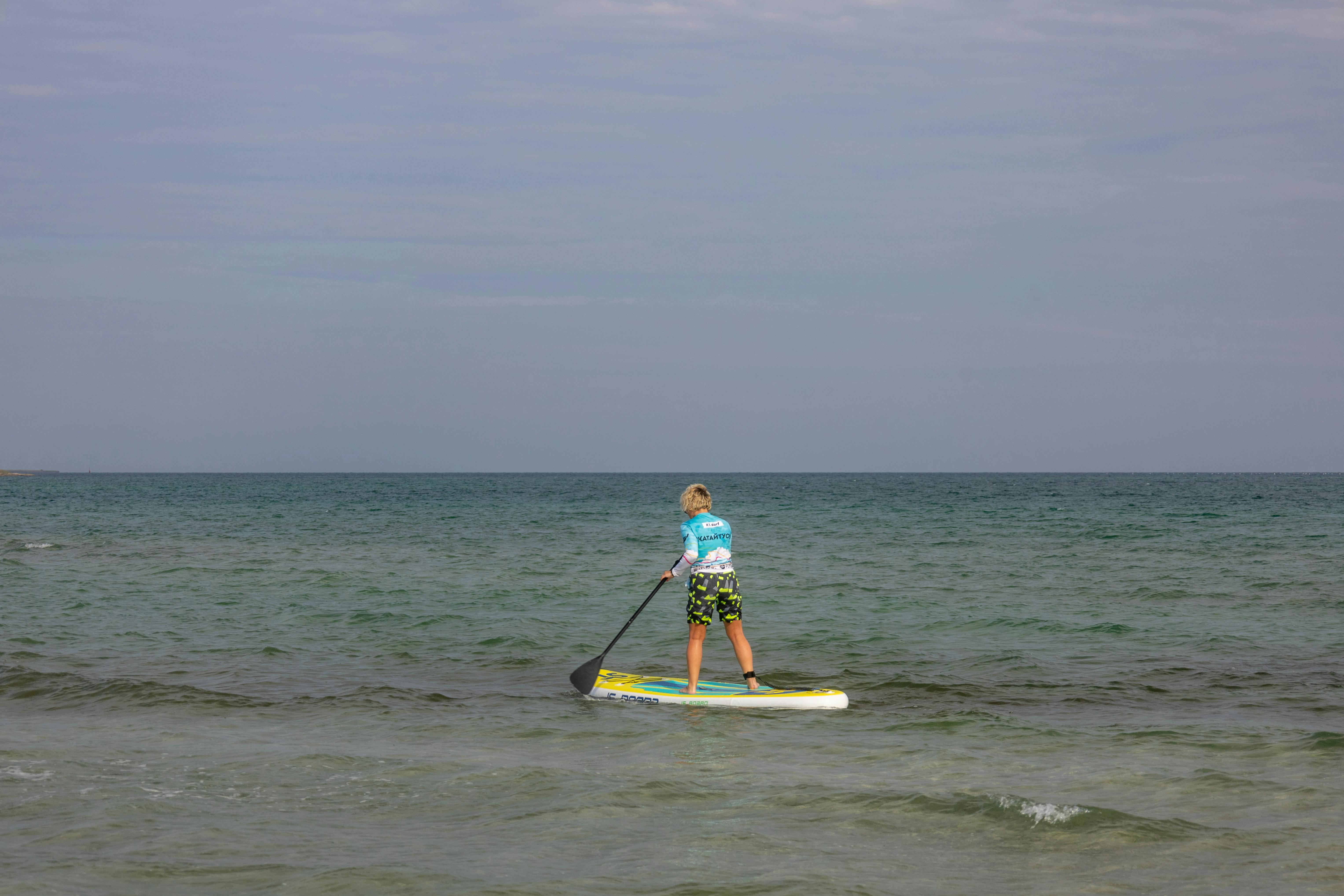 A Person Paddle Boarding on the Sea · Free Stock Photo