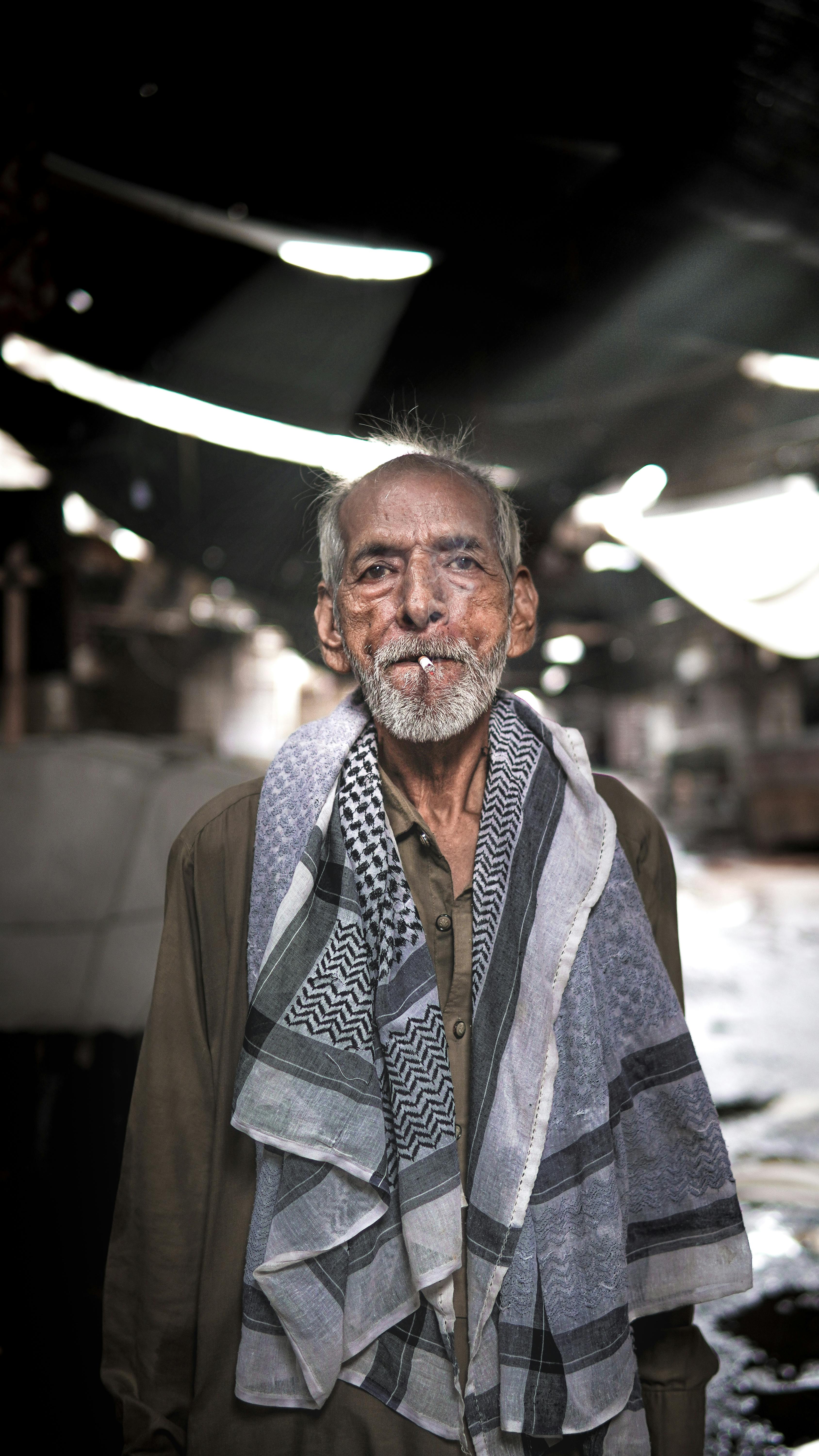 Man Standing and Smoking Cigarette With Traditional Scarf · Free Stock ...