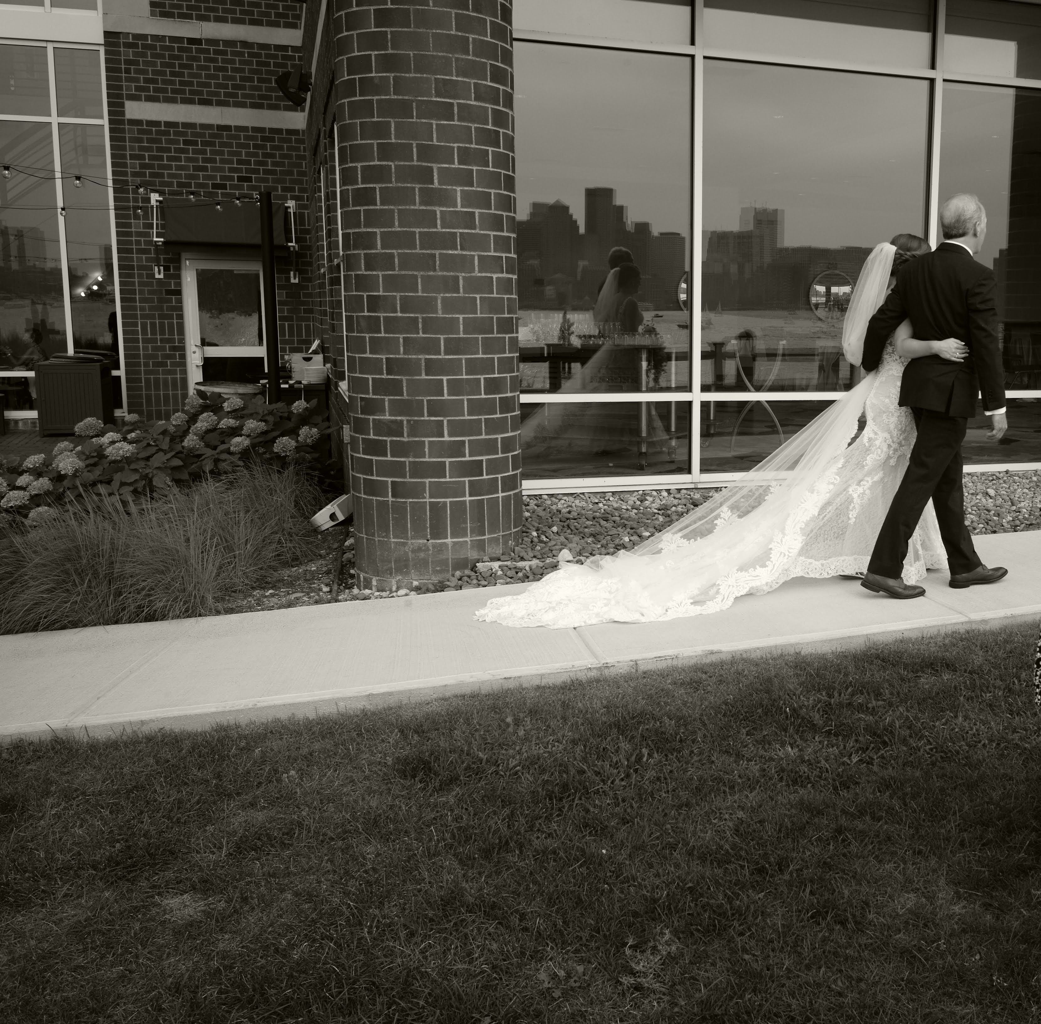 Monochrome Photo of a Newlywed Couple Walking Together · Free Stock Photo