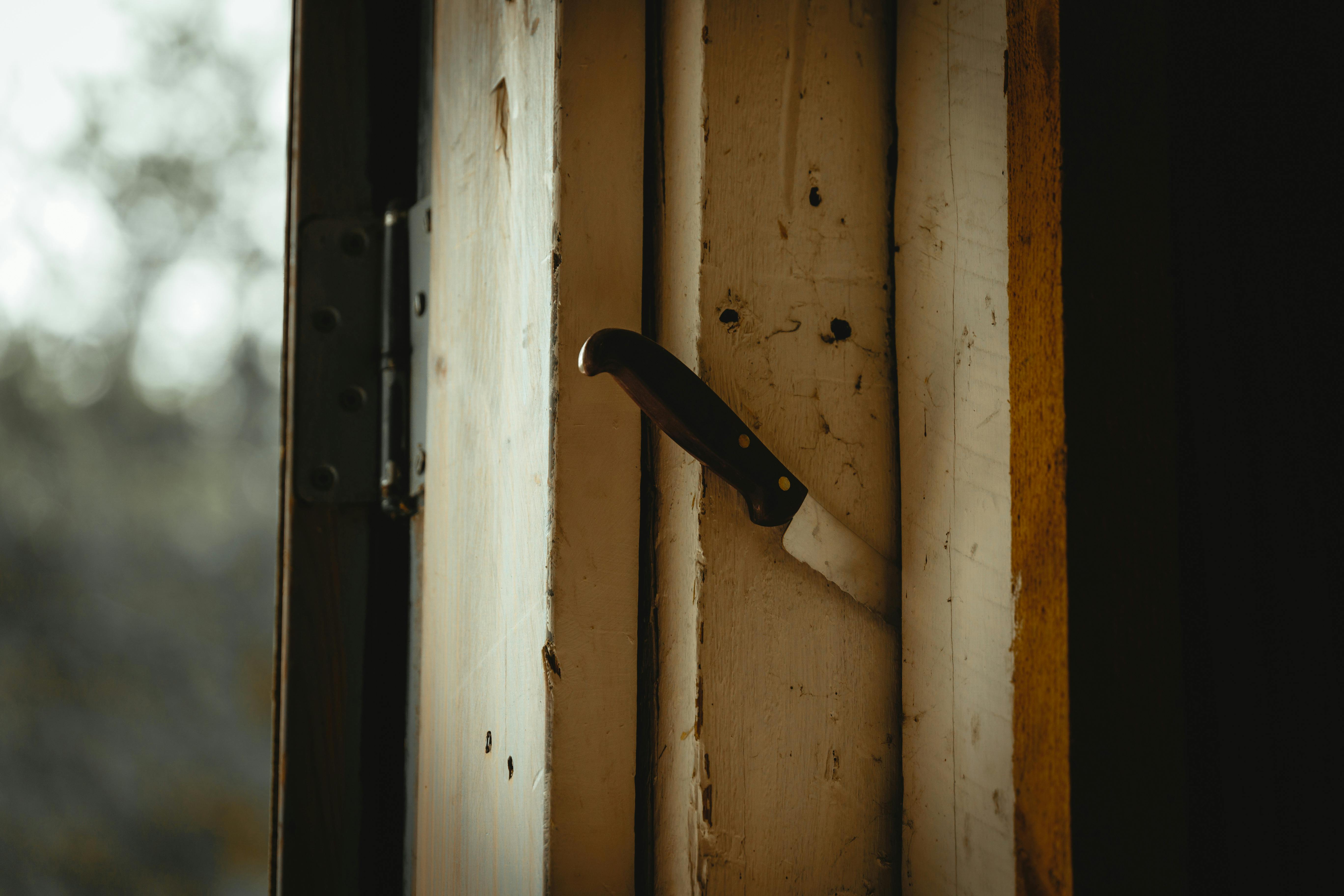 A Knife in a Gap by a Window · Free Stock Photo