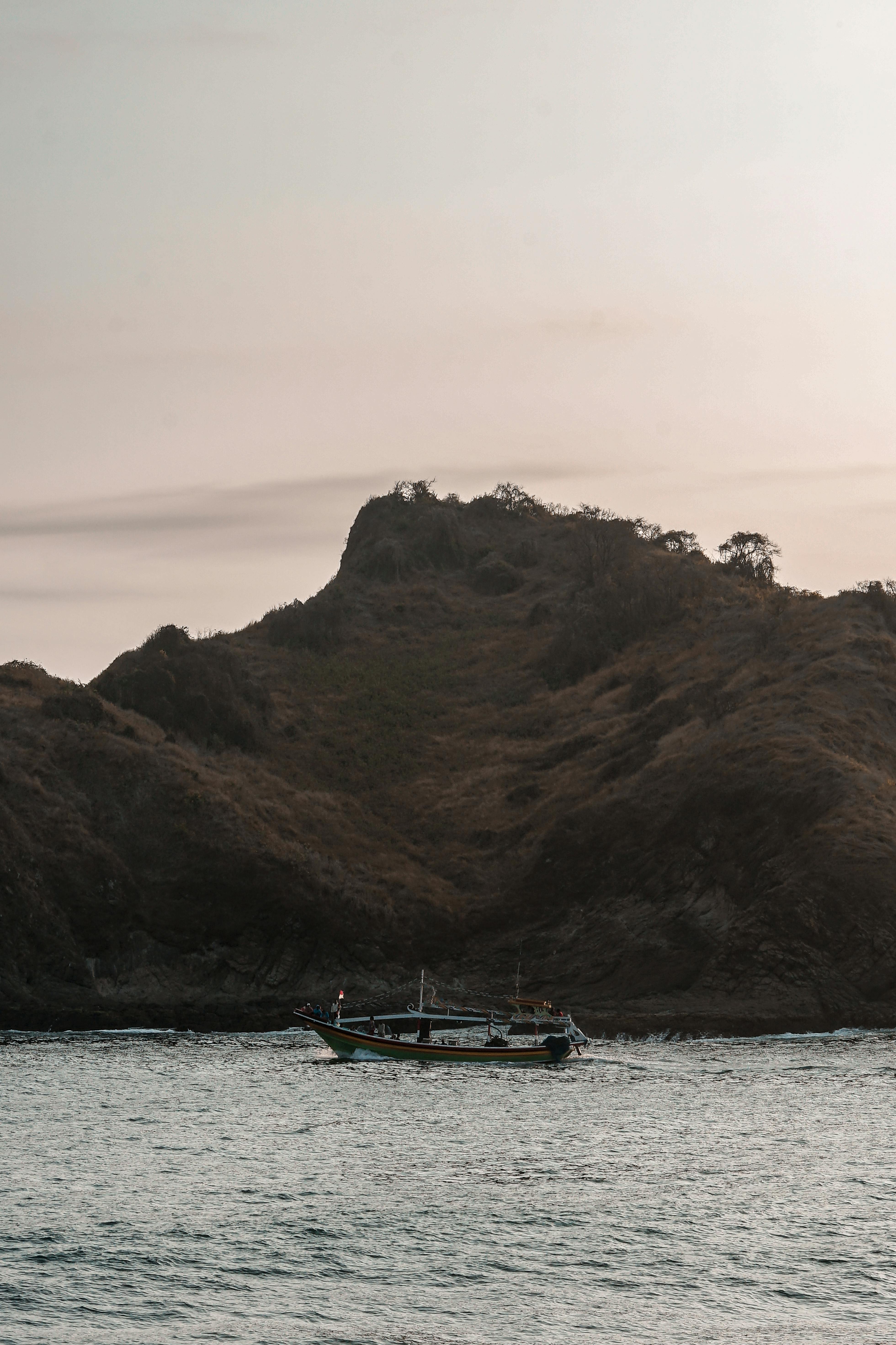 Brown Sailboat Floating on a Calm Body of Water · Free Stock Photo