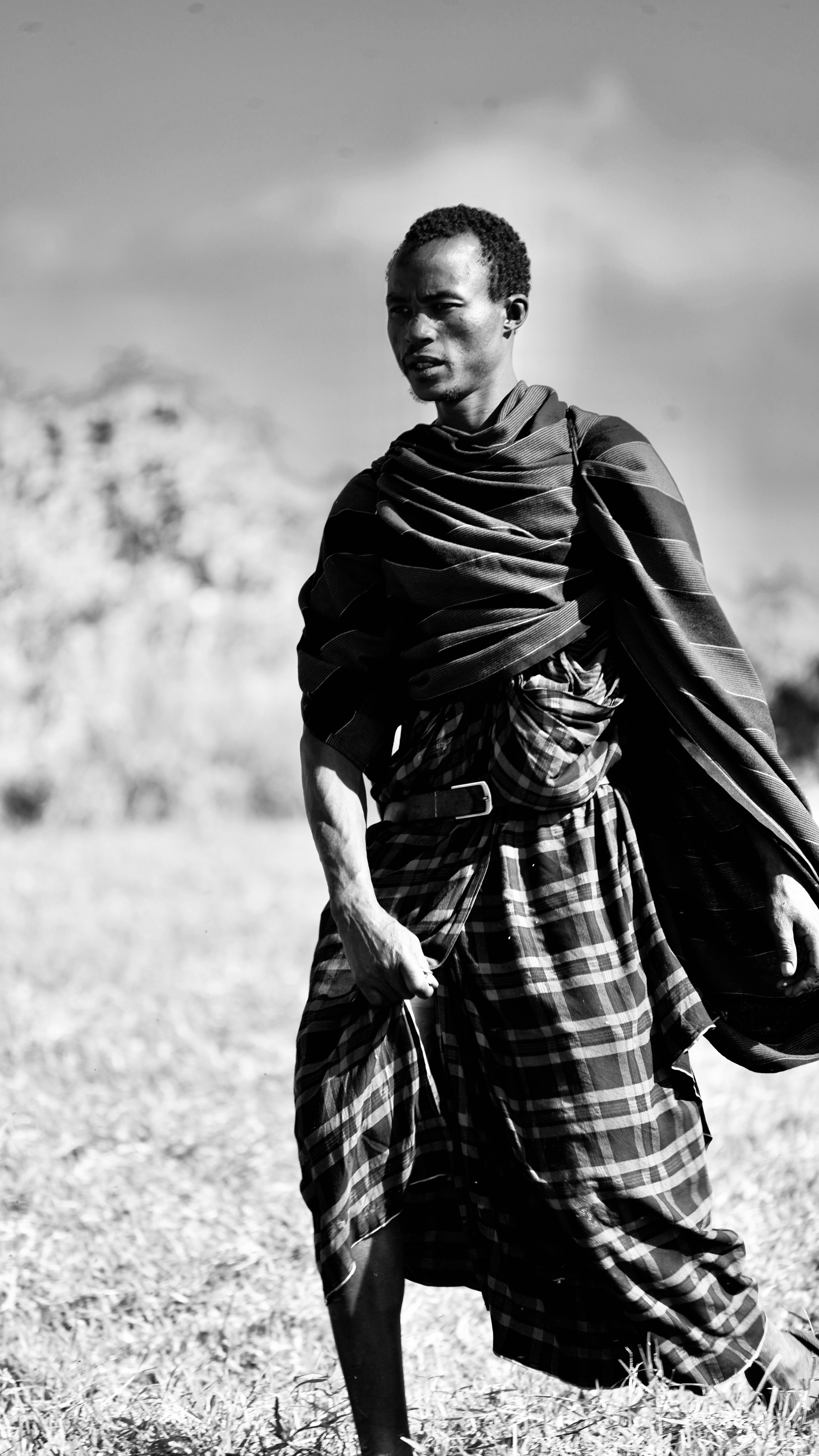 Man in Traditional in Traditional Clothes Walking on Grass Field · Free ...