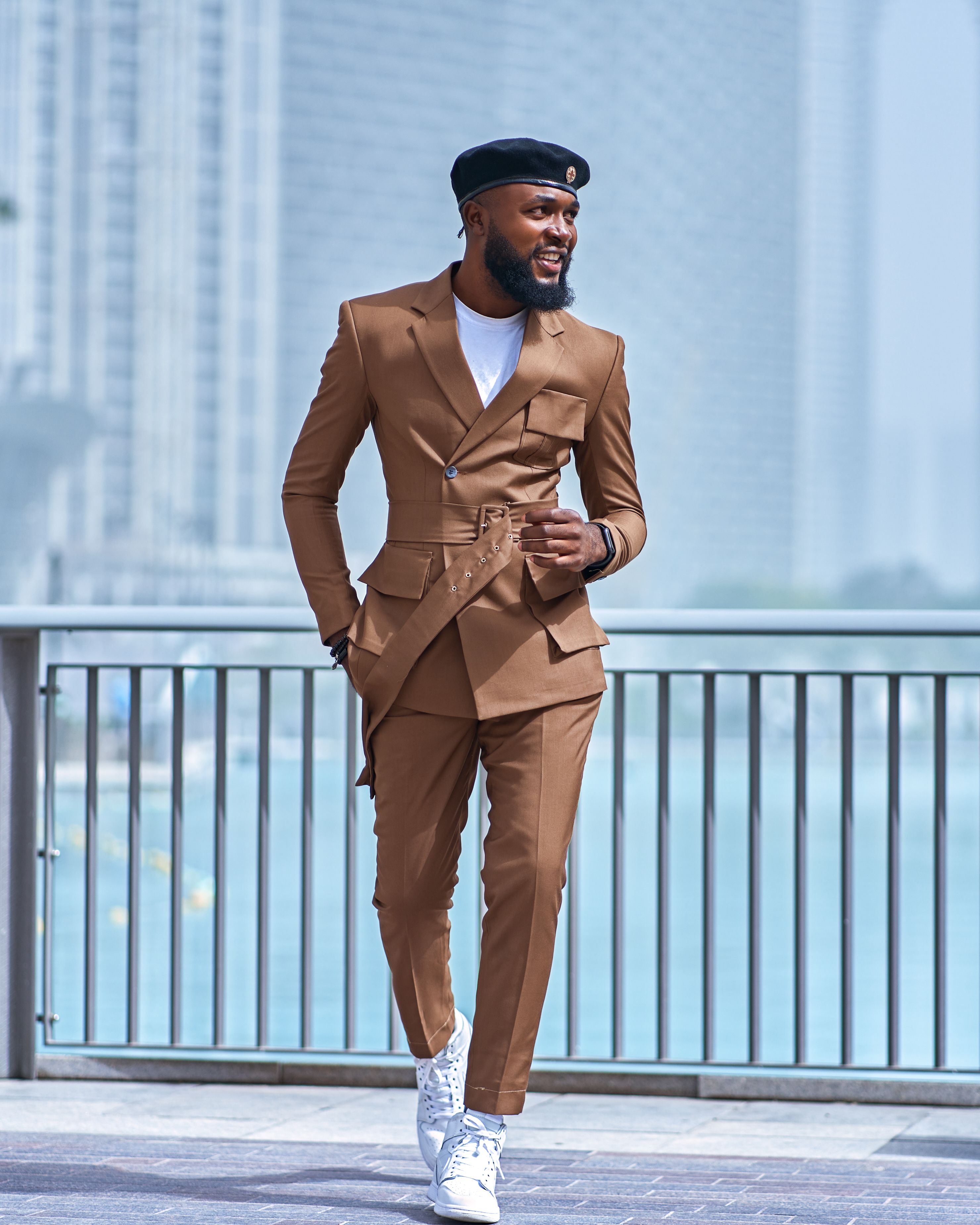 Man Posing in a Beige Suit and Trousers on a City Bridge · Free Stock Photo
