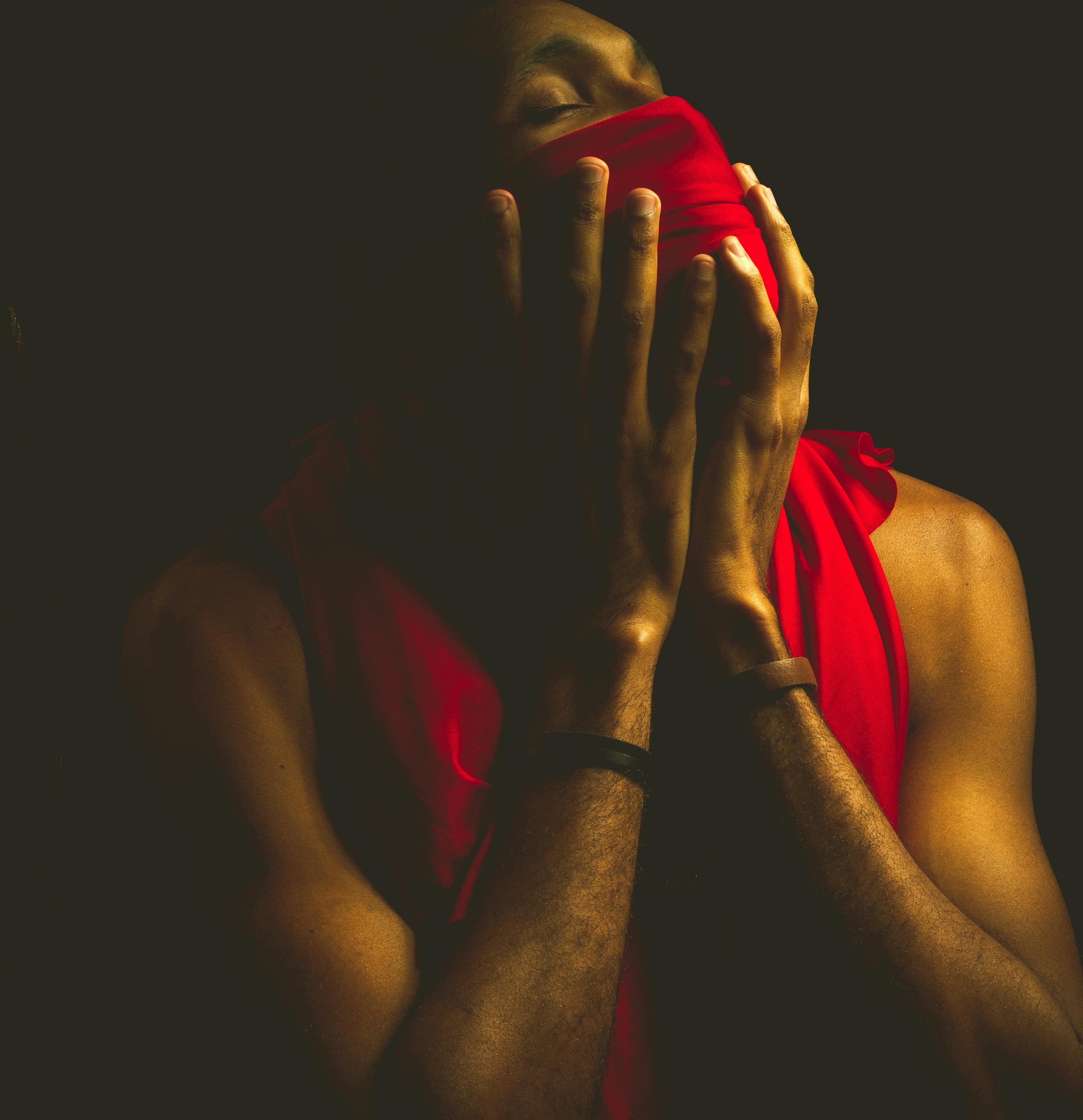 A Person Covering Face with Red Cloth · Free Stock Photo