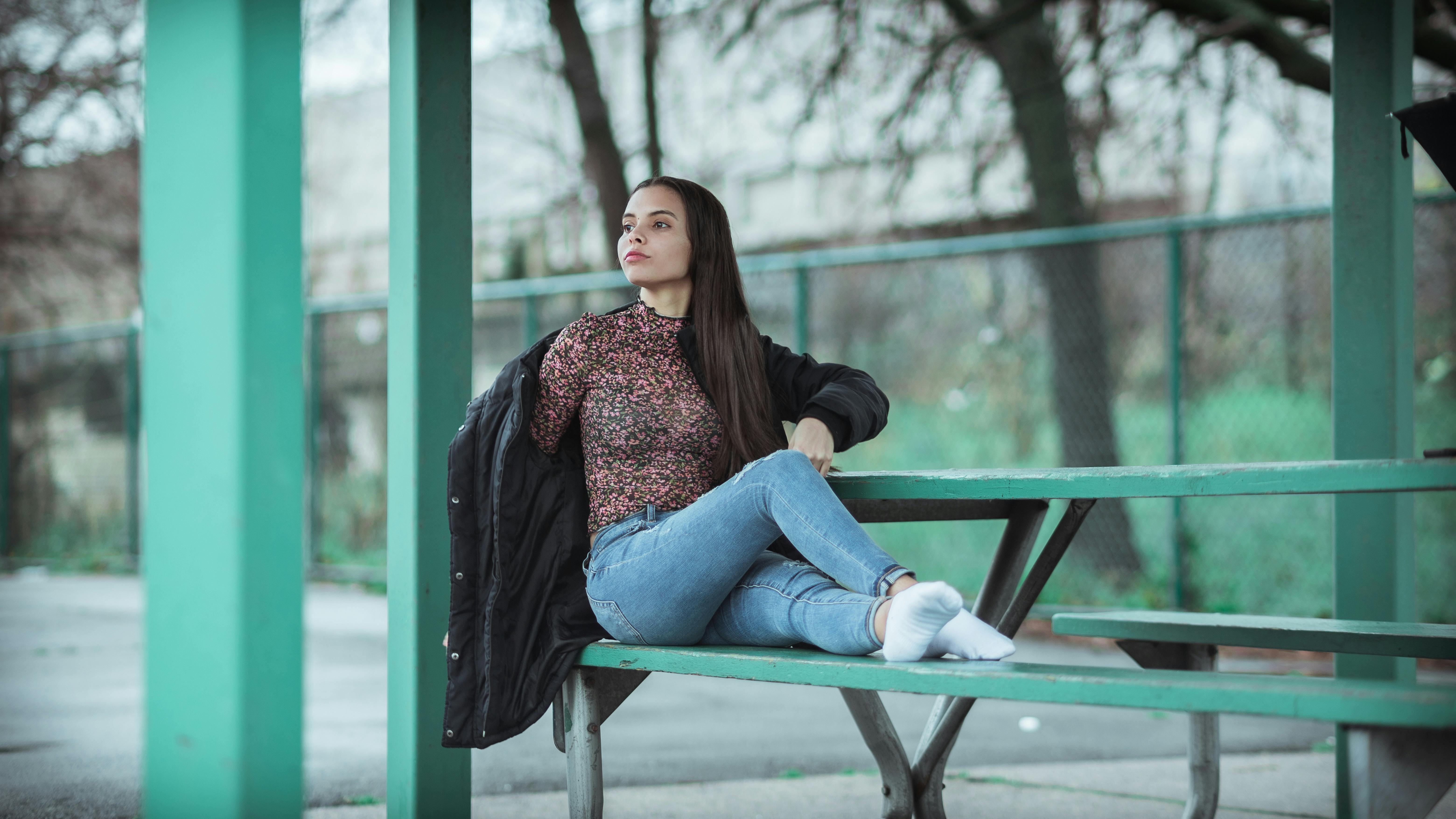 A Woman Sitting on a Wooden Bench · Free Stock Photo