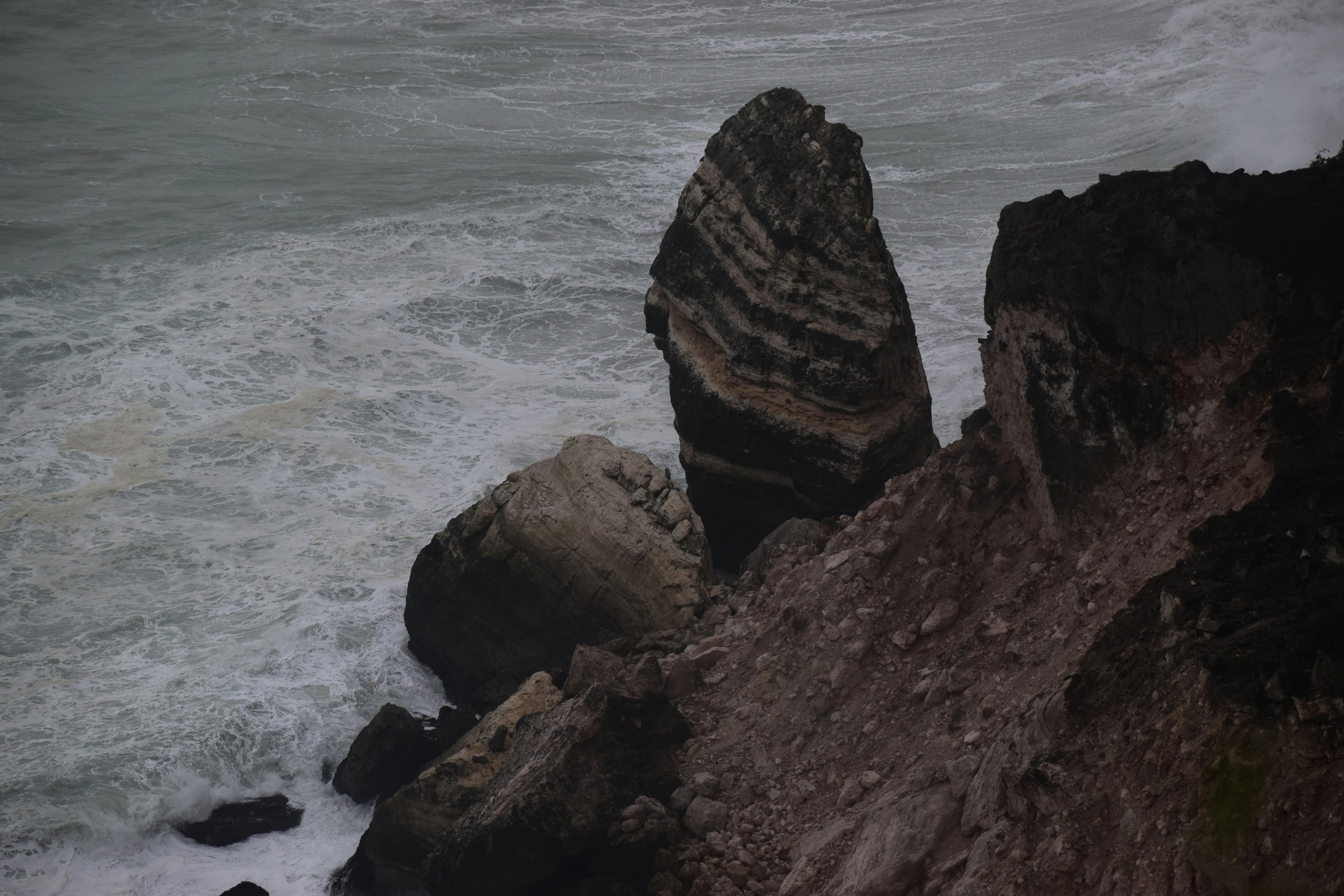 High-Angle Shot of Cliff Rocks near Ocean · Free Stock Photo