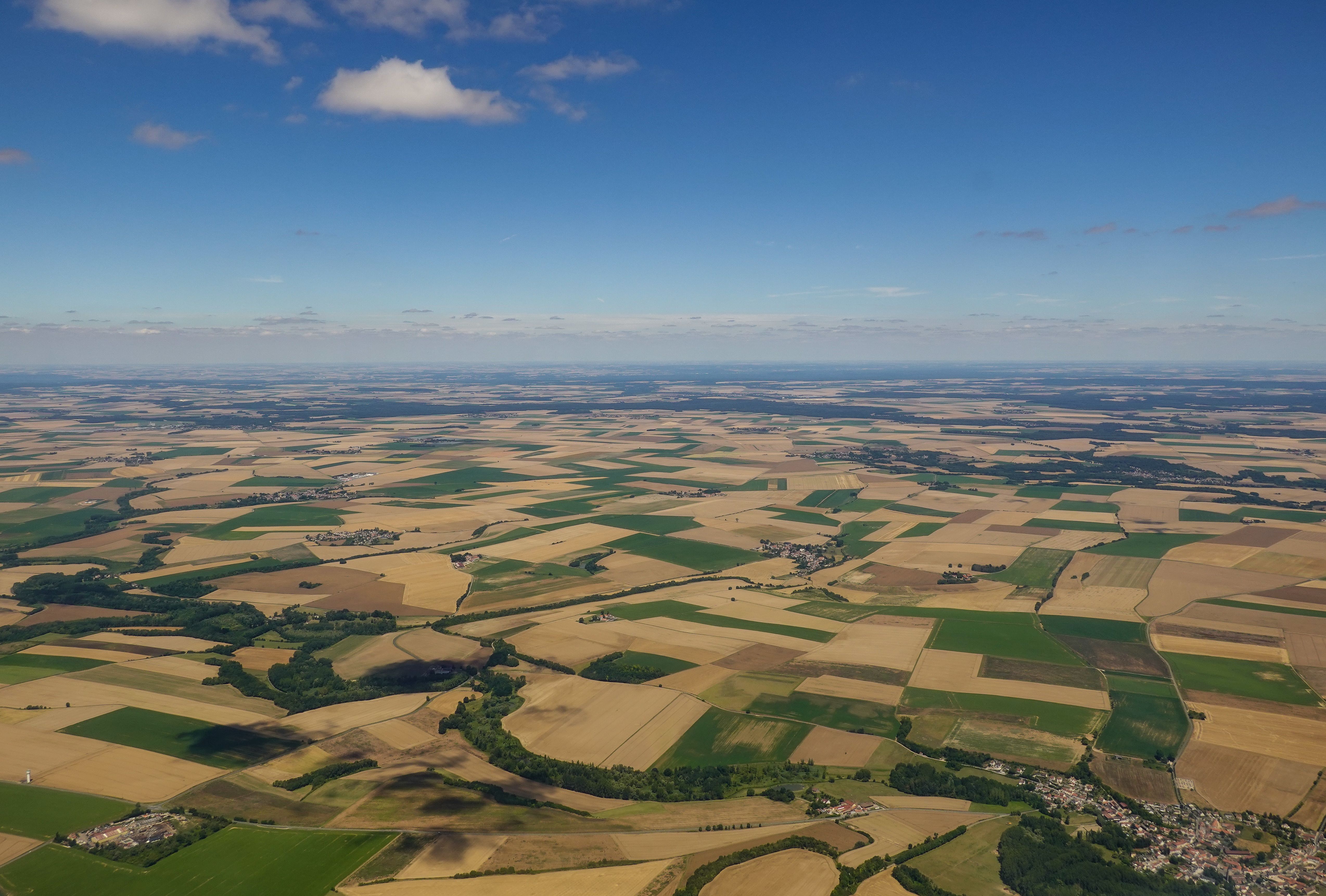Aerial View of Croplands under a Blue Sky · Free Stock Photo