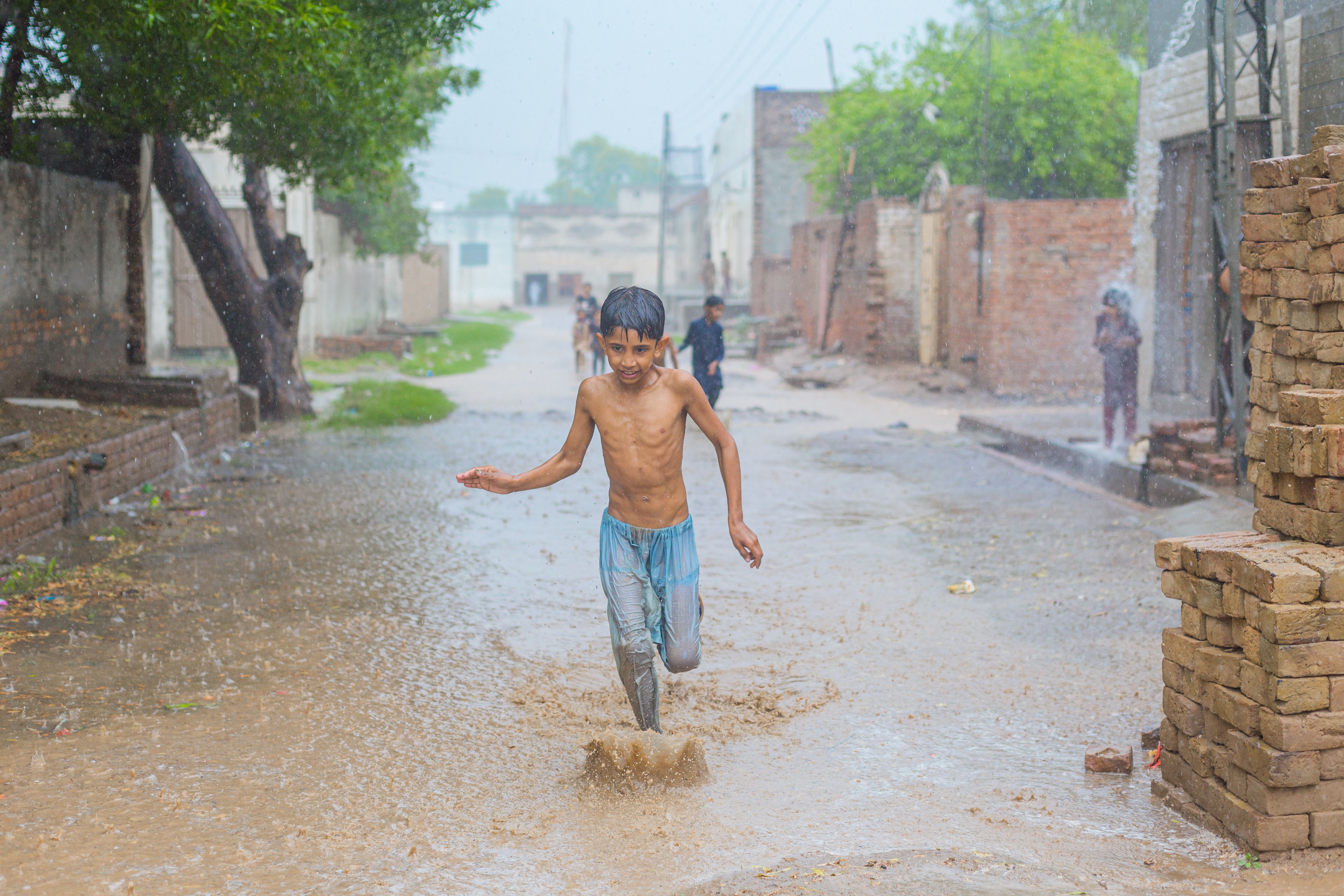 Boys Playing on Flooded Street · Free Stock Photo
