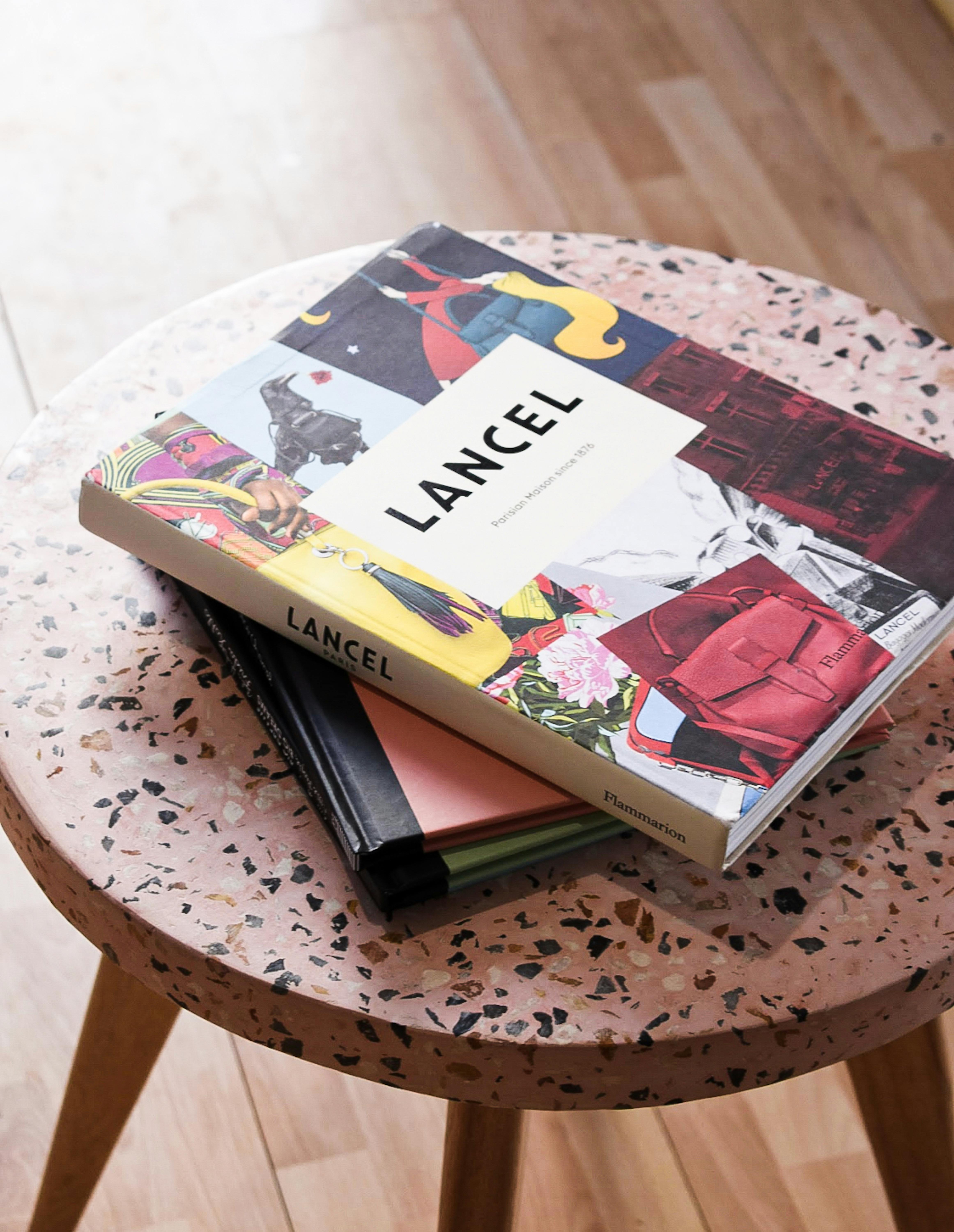 Folded Scarf on a Round Table Near White Wall · Free Stock Photo