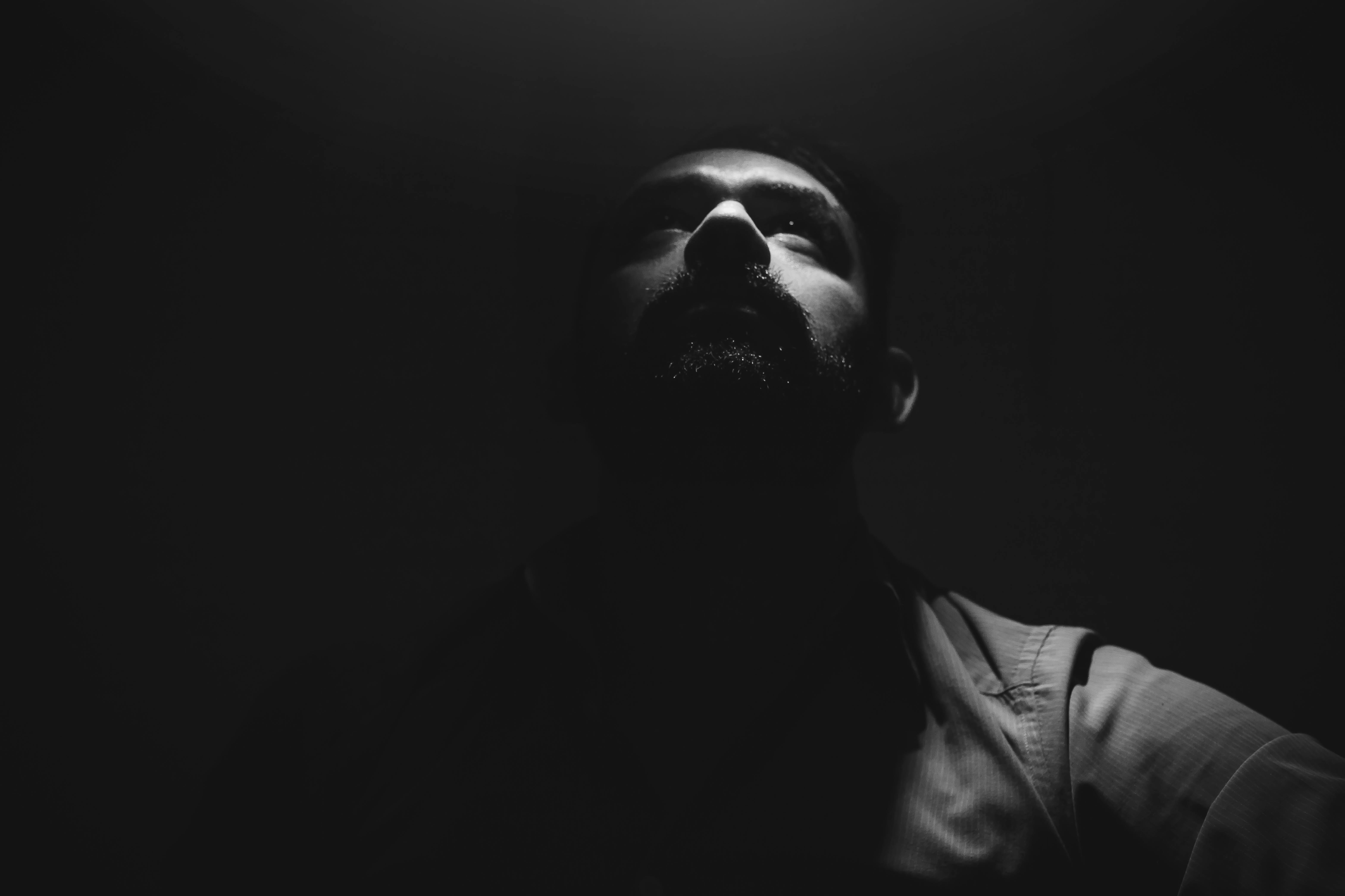 Grayscale Photo of a Bearded Man Looking Up · Free Stock Photo