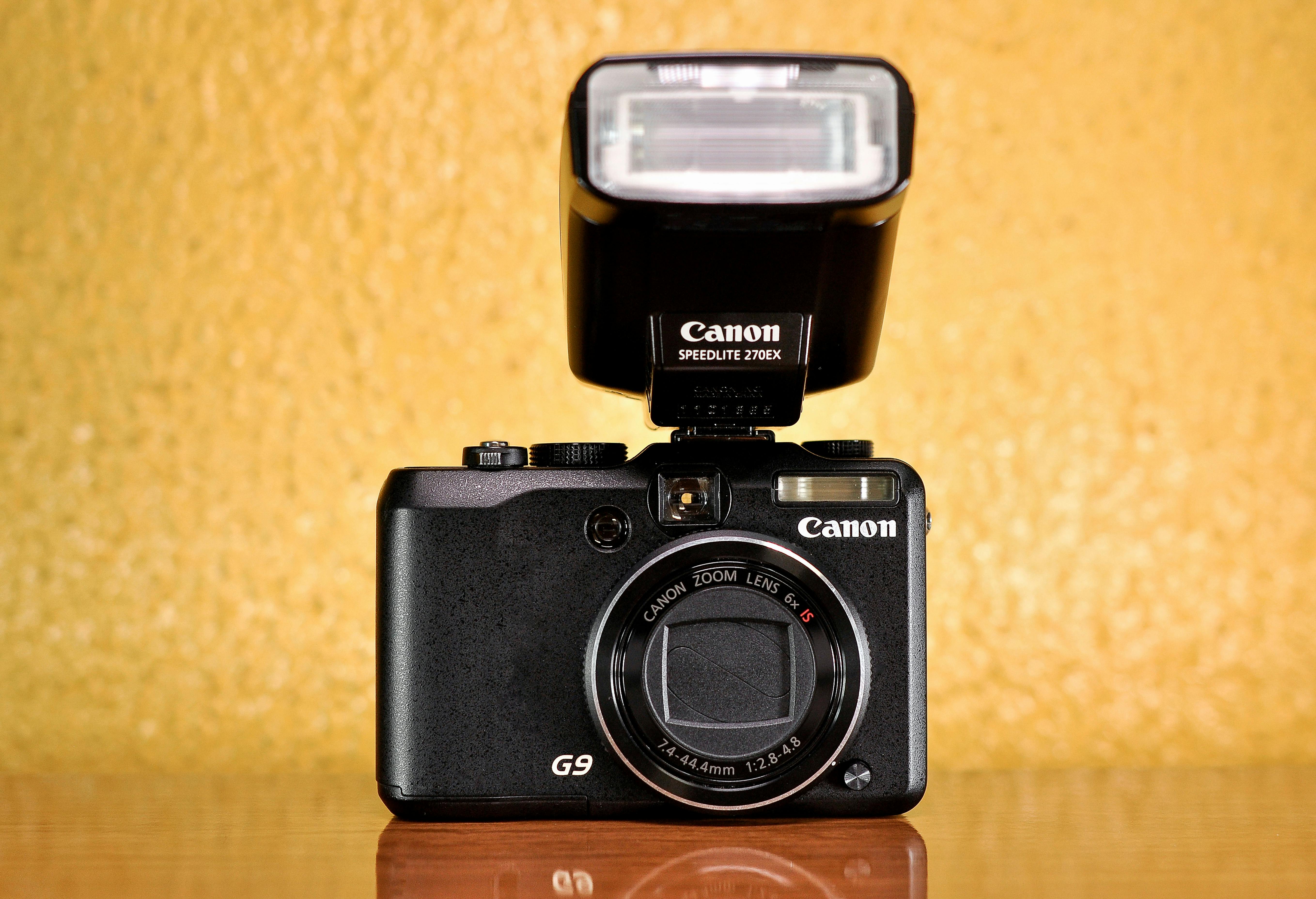 Black Canon Dslr Camera on Brown Wooden Table · Free Stock Photo