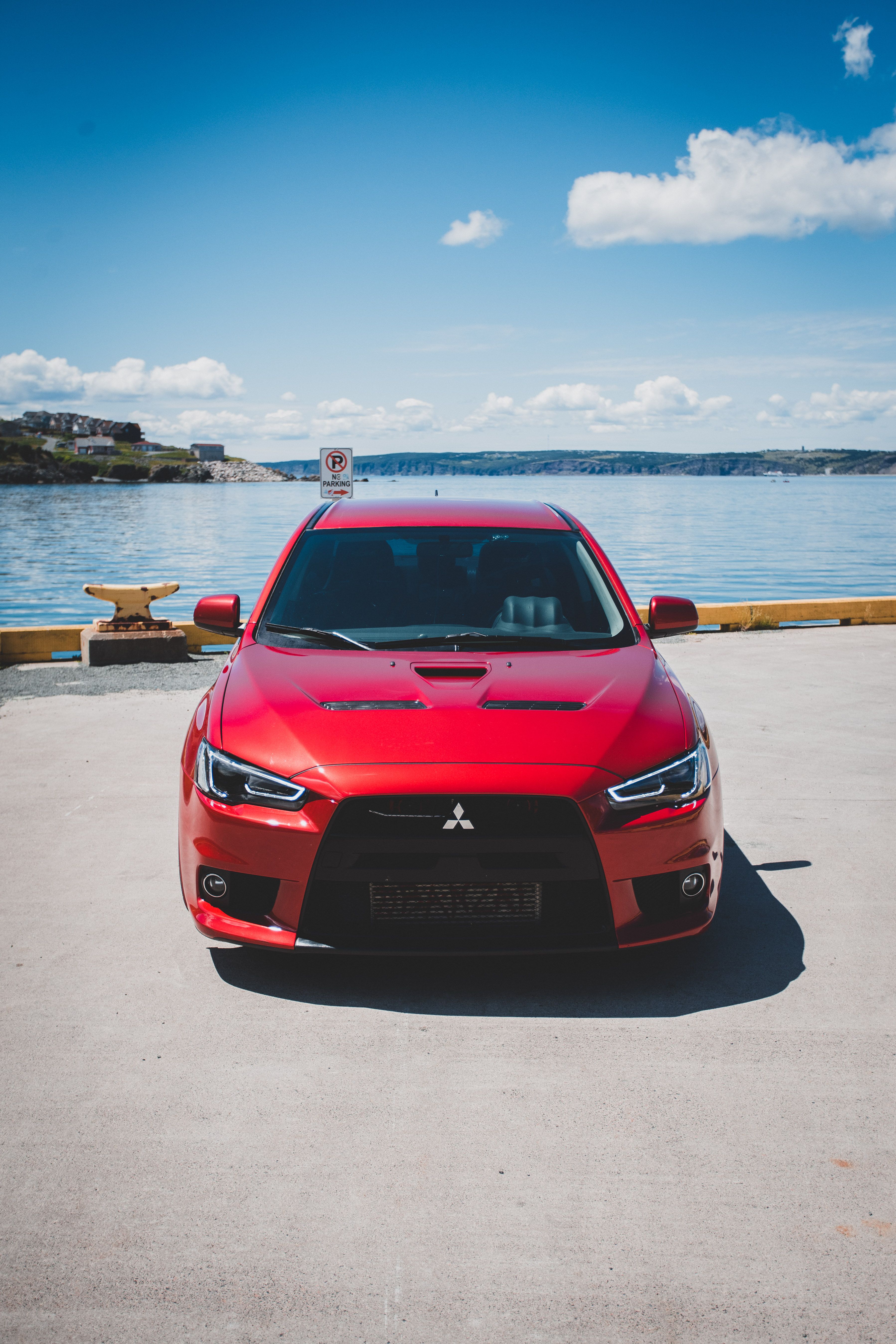Red Car Parked Near the Ocean · Free Stock Photo