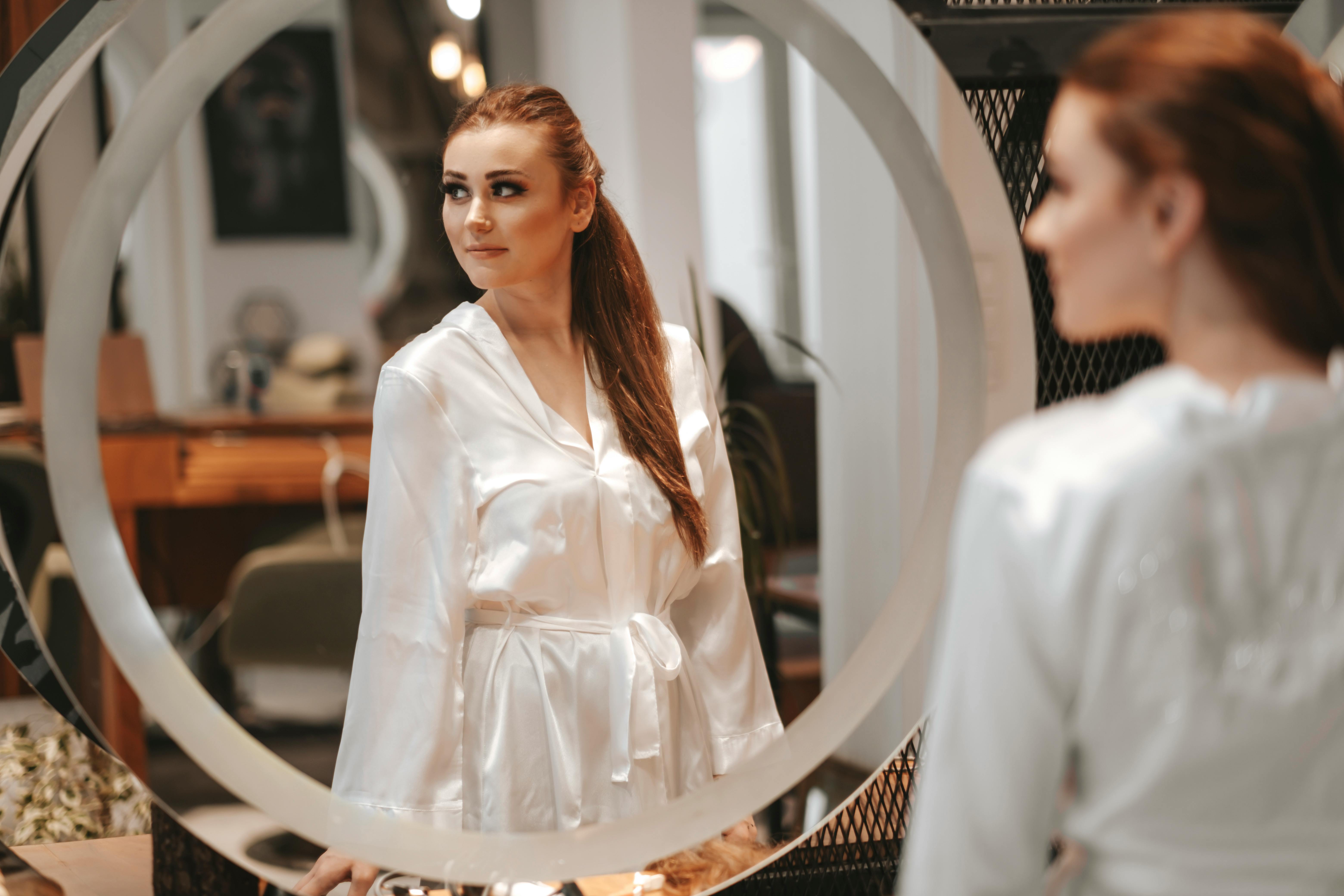 Reflection of a Woman in the Round Mirror · Free Stock Photo