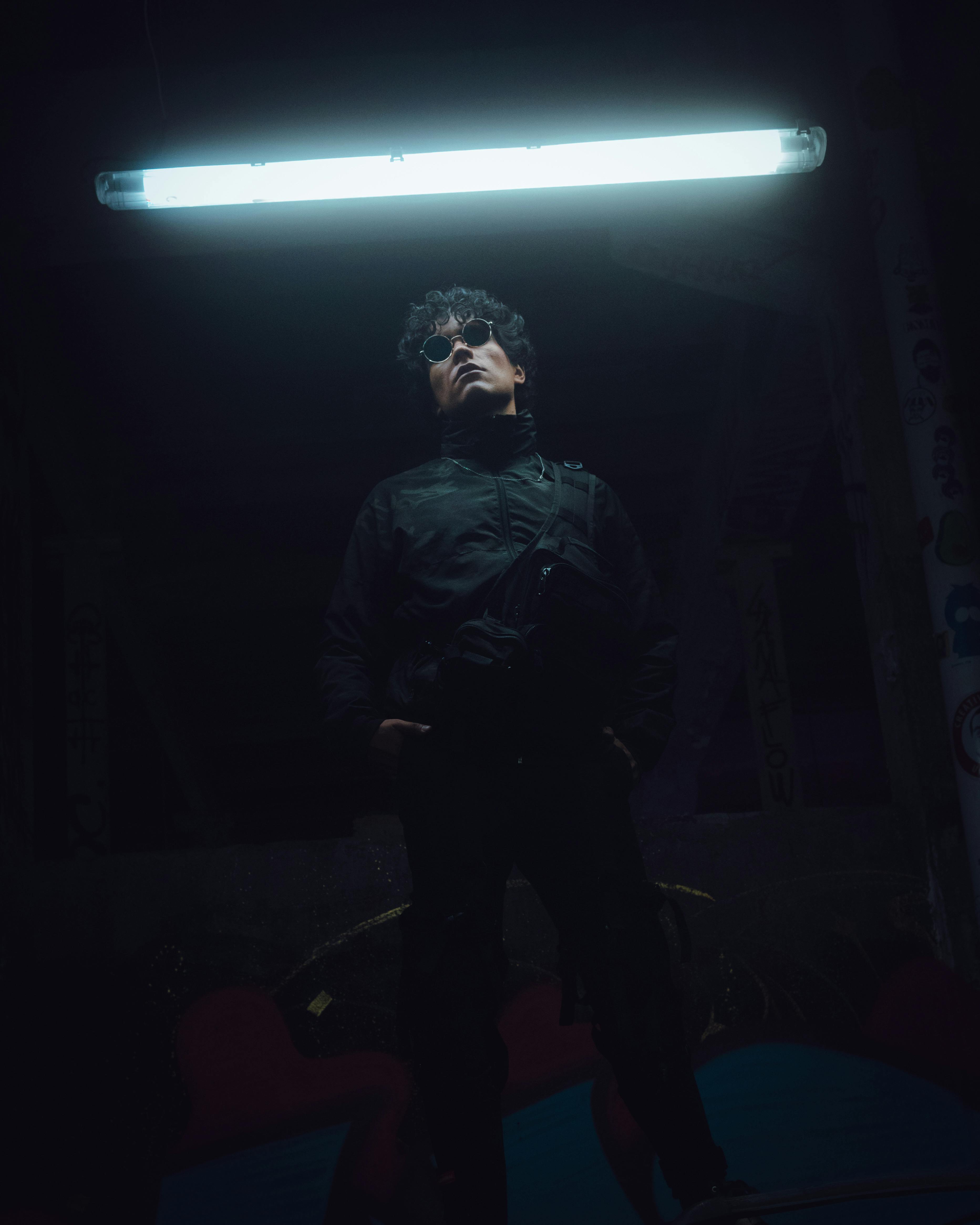 A Man with Sunglasses Standing under a Light · Free Stock Photo