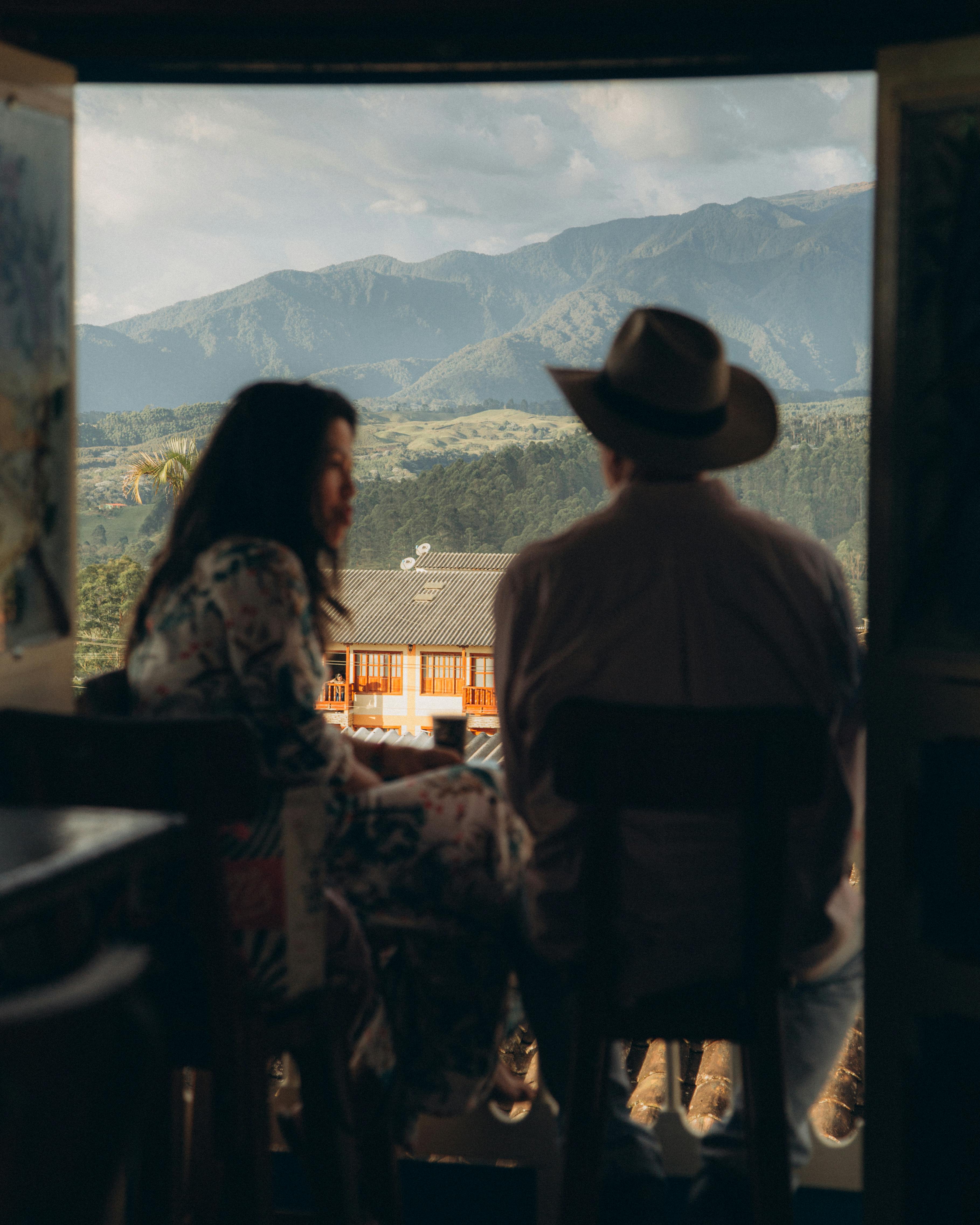 Man in Cowboy Hat Sitting on Stool · Free Stock Photo