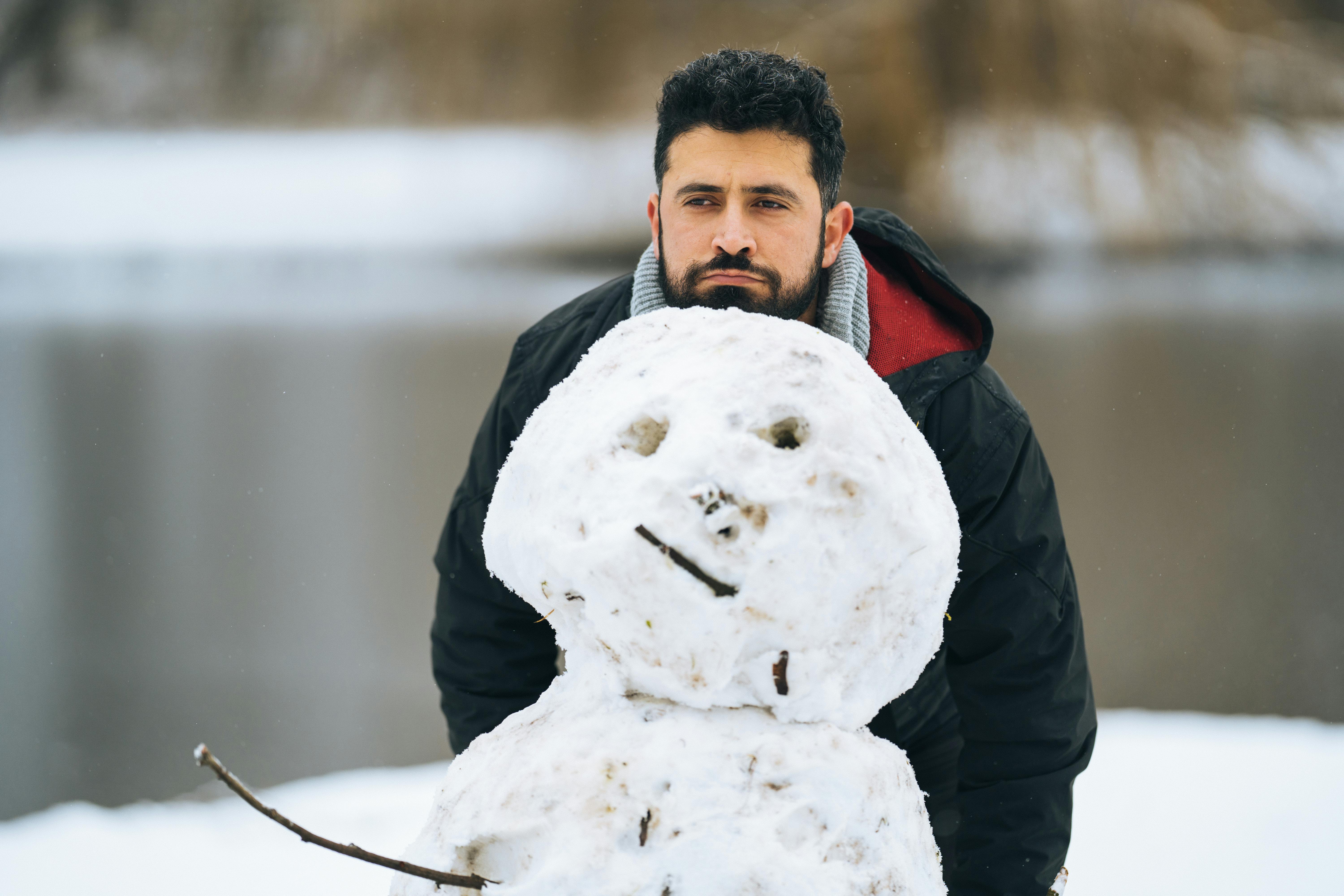 Bearded Man Behind a Snowman · Free Stock Photo