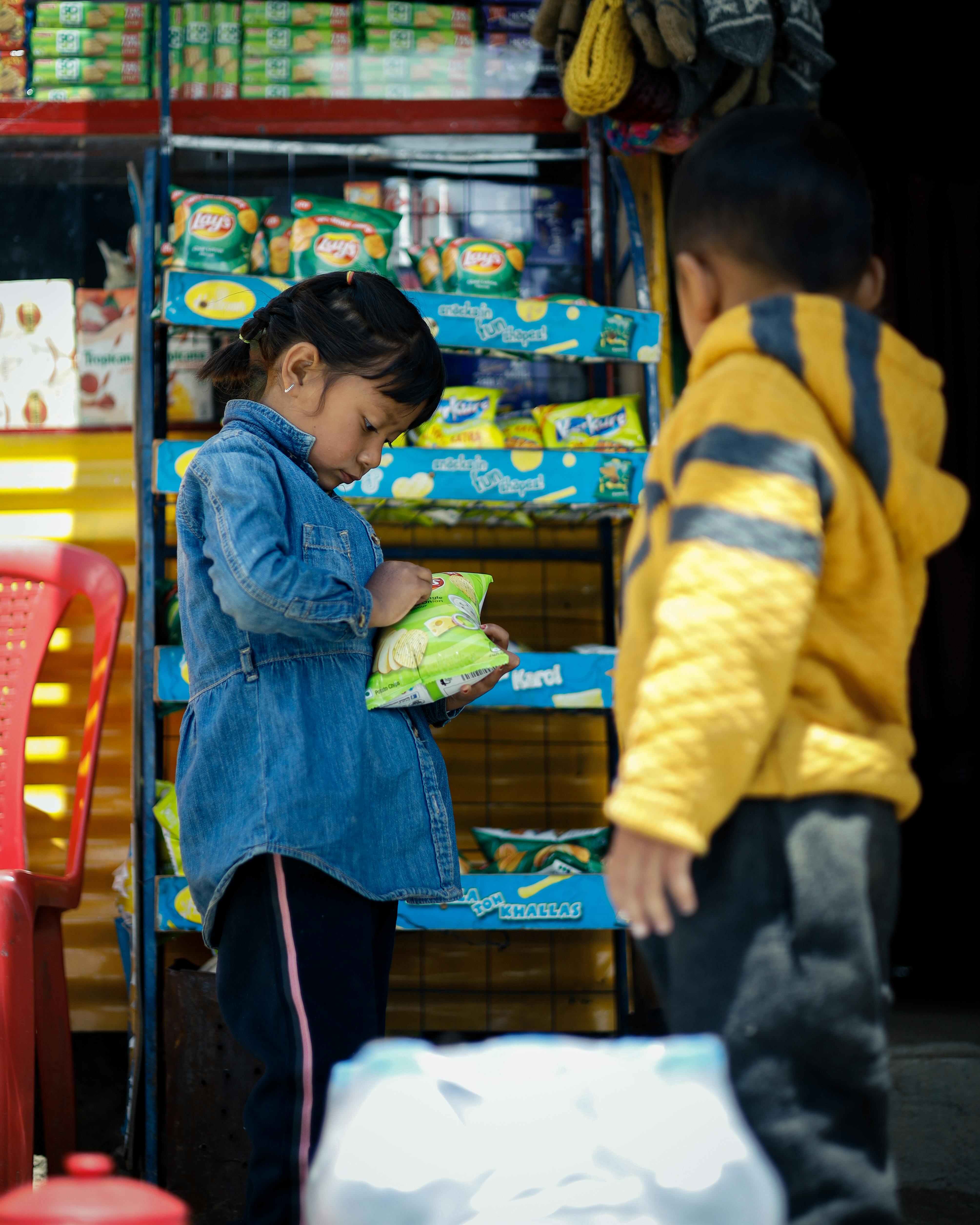 Children Picking Bag of Chips in Grocery Store · Free Stock Photo