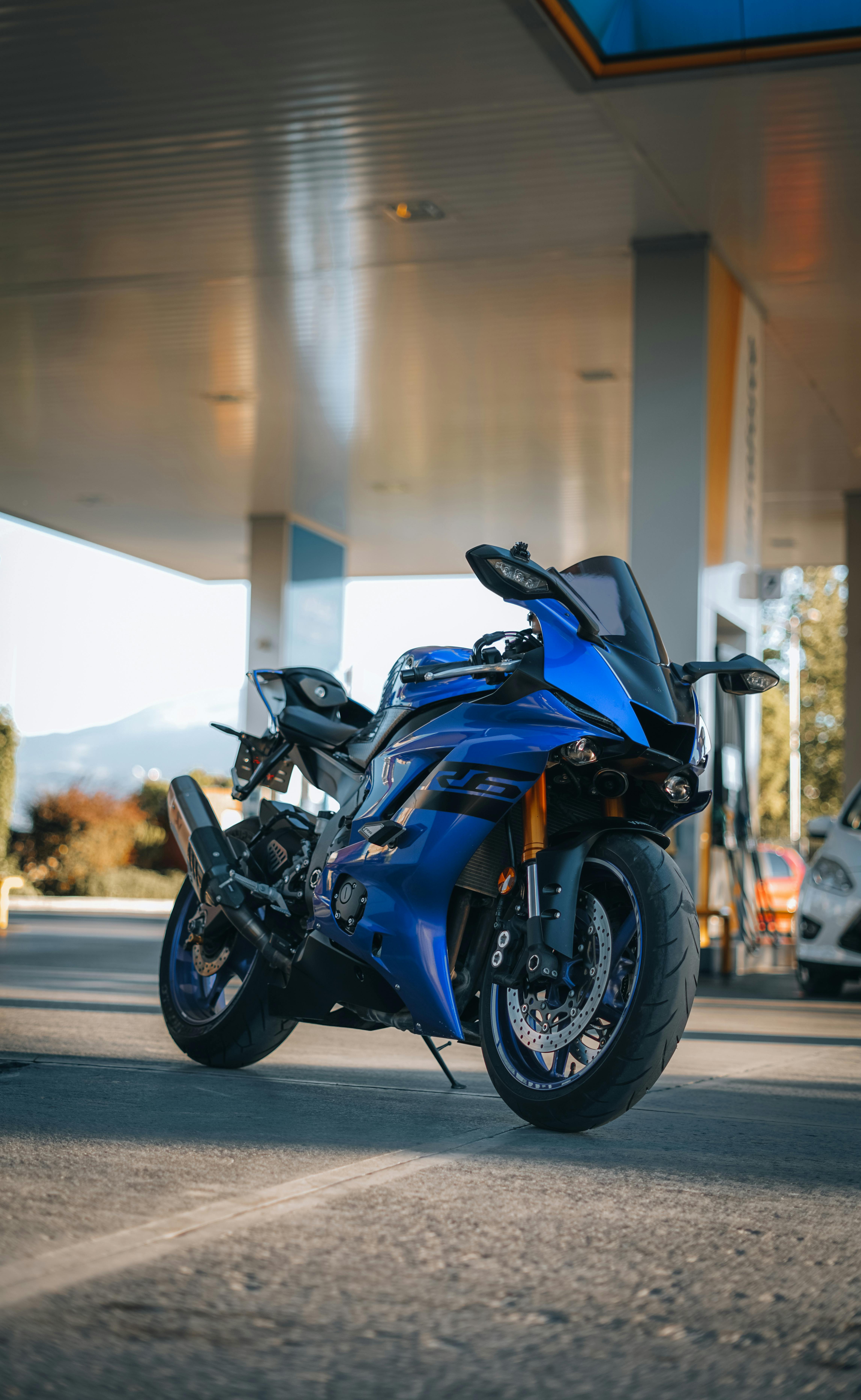 Blue Sports Bike Parked on Concrete Pavement · Free Stock Photo