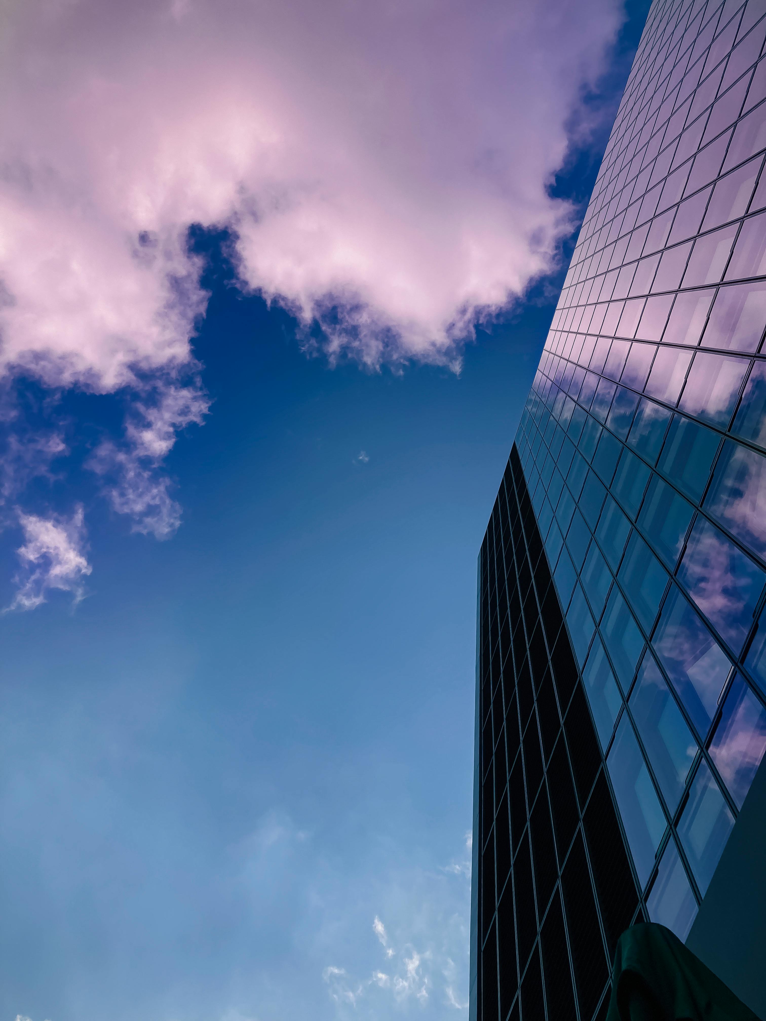 High Rise Building with Glass Windows Under Blue Sky · Free Stock Photo