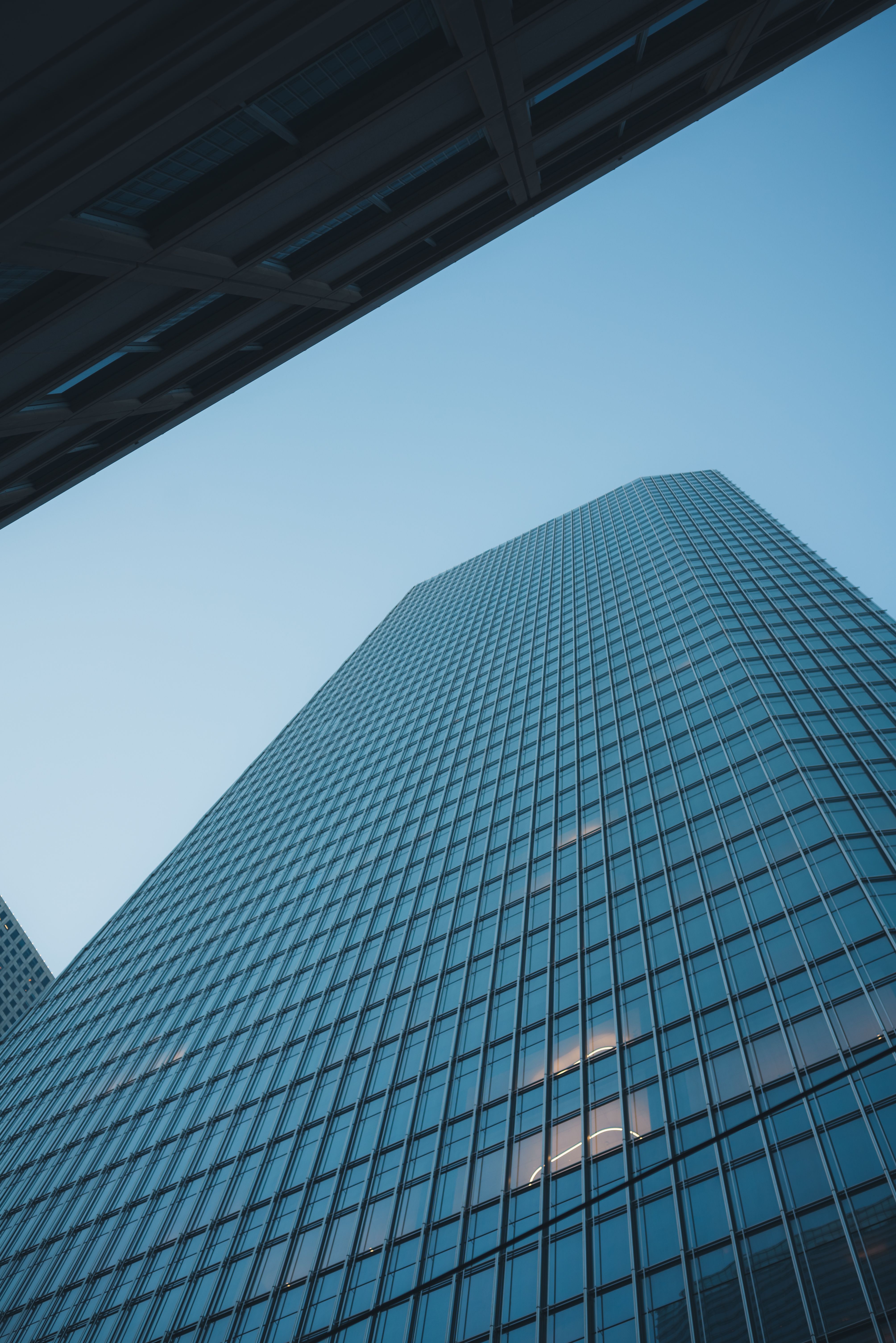 High Rise Building with Glass Panels Under a Clear Blue Sky · Free ...