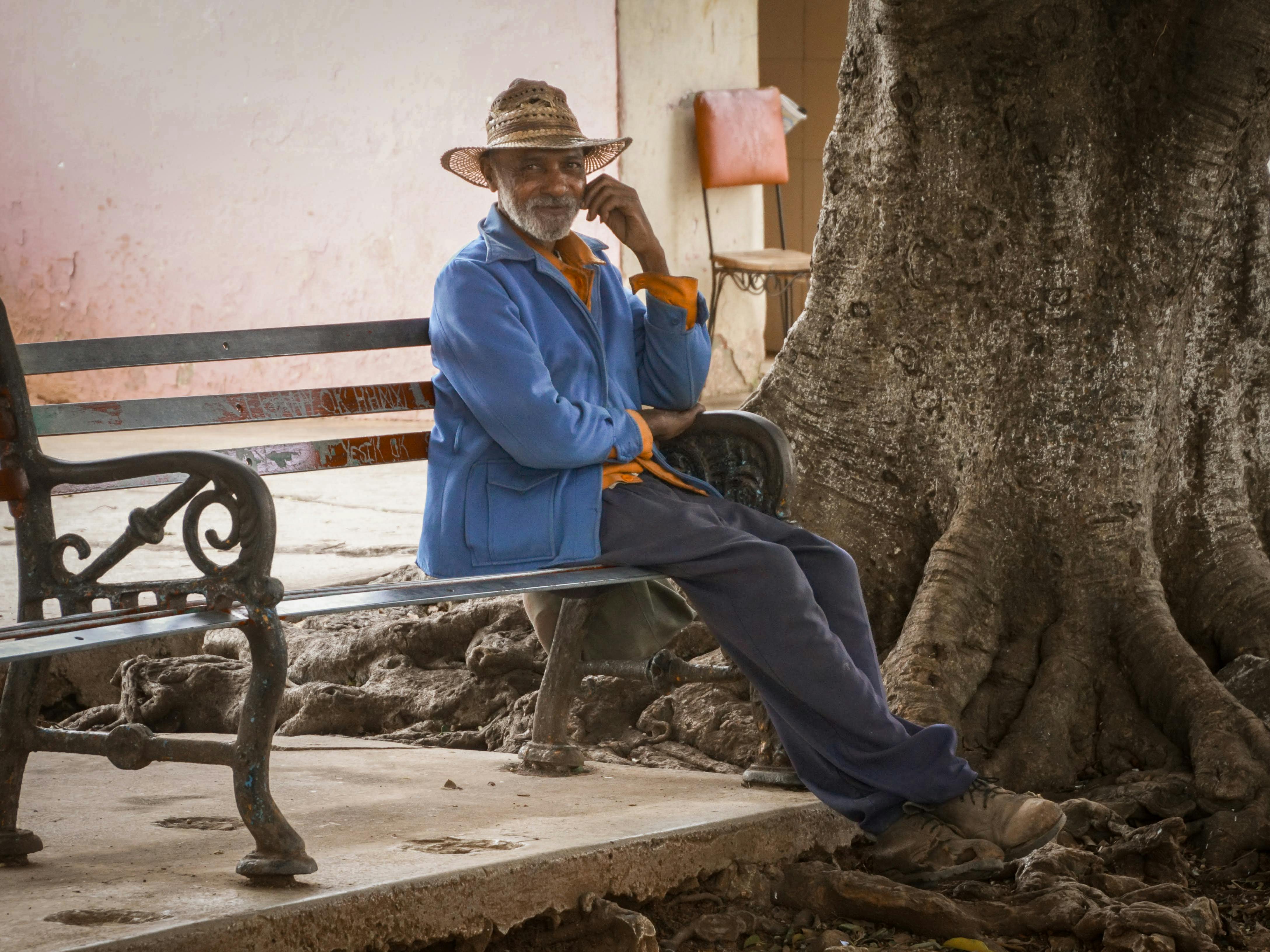 Black and White Photo of a Man in Cowboy Hat Sitting on a Bench · Free ...
