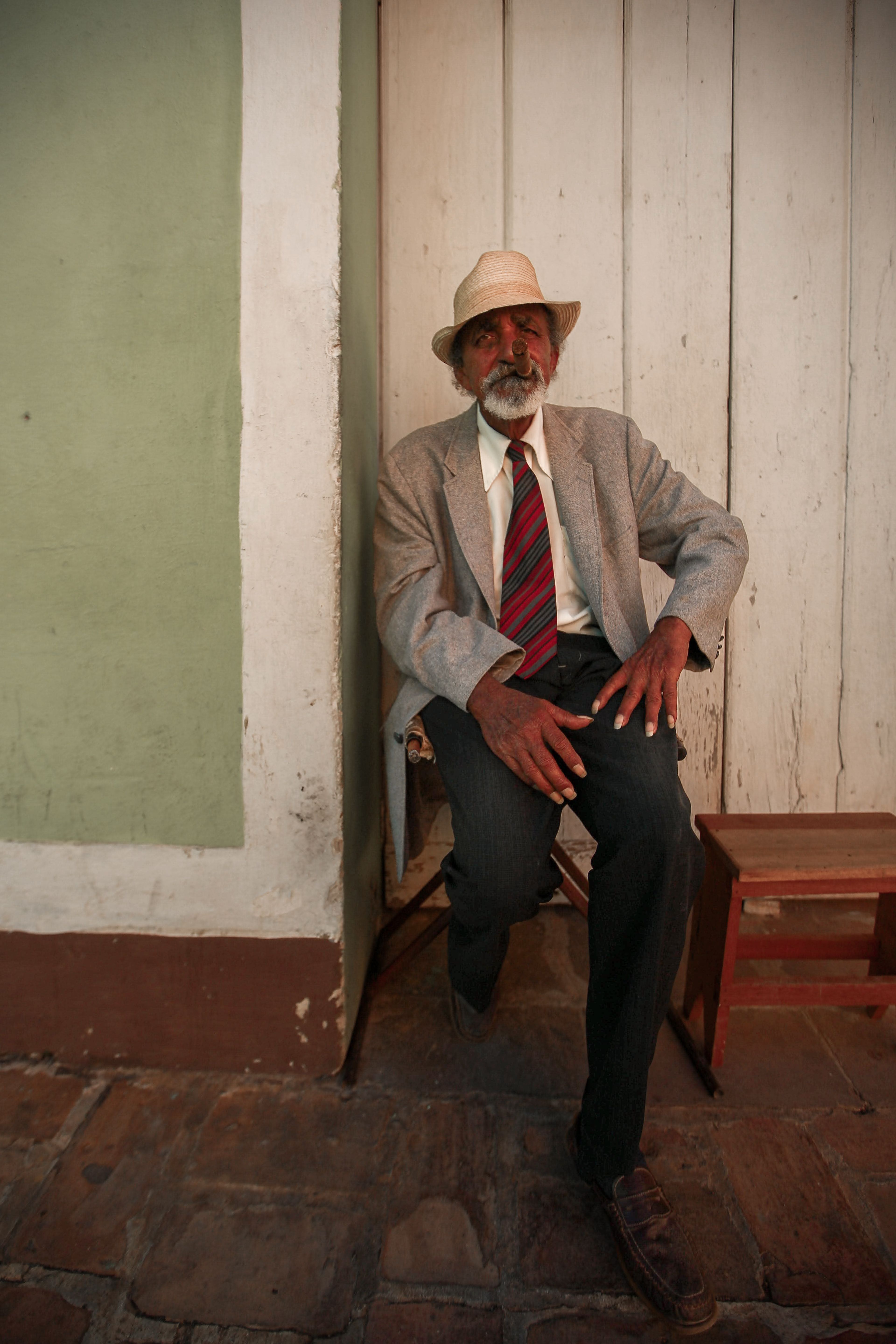 Elderly Man in a Suit Smoking a Cigar · Free Stock Photo