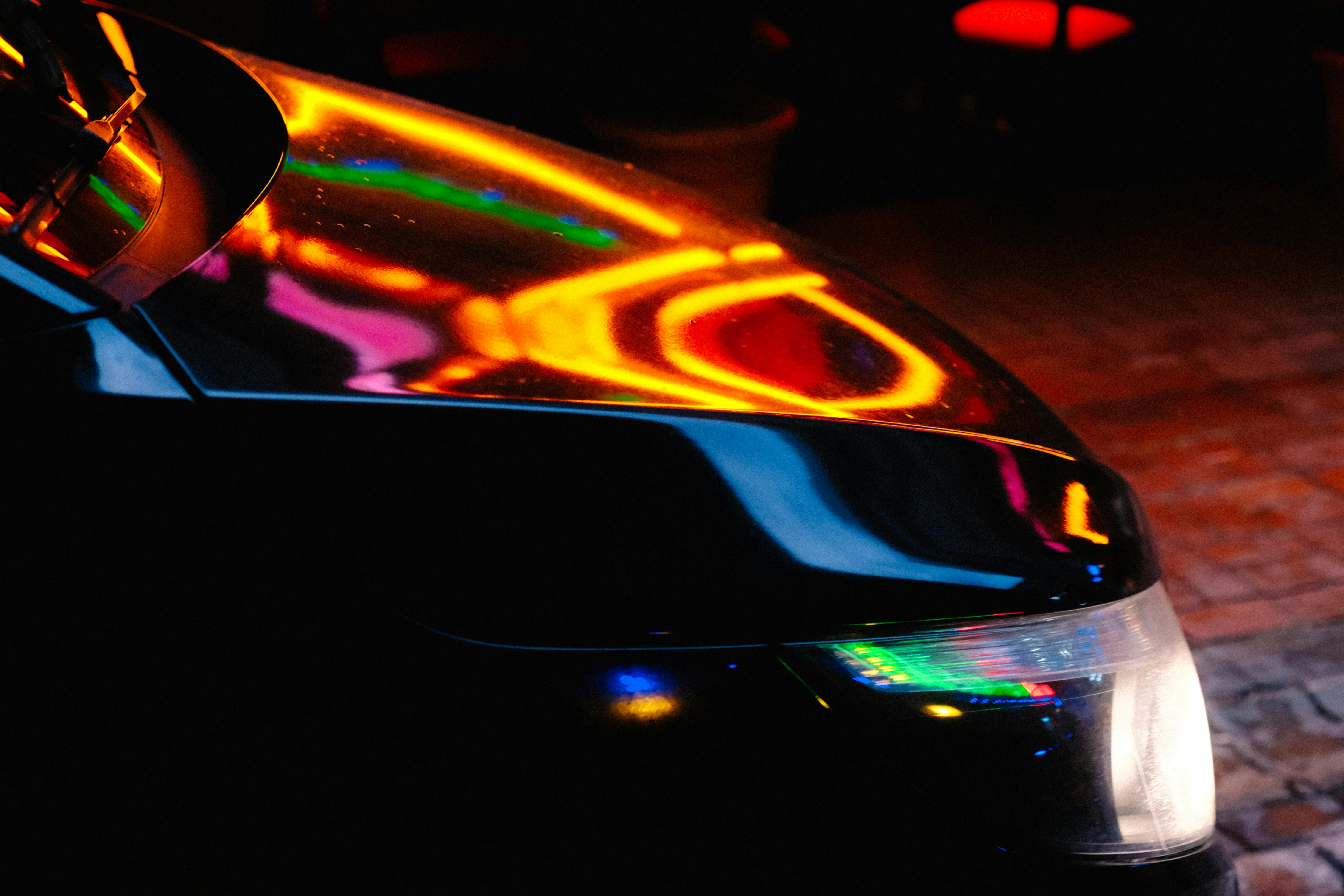 A Close-Up Shot of a Black Car at Night · Free Stock Photo