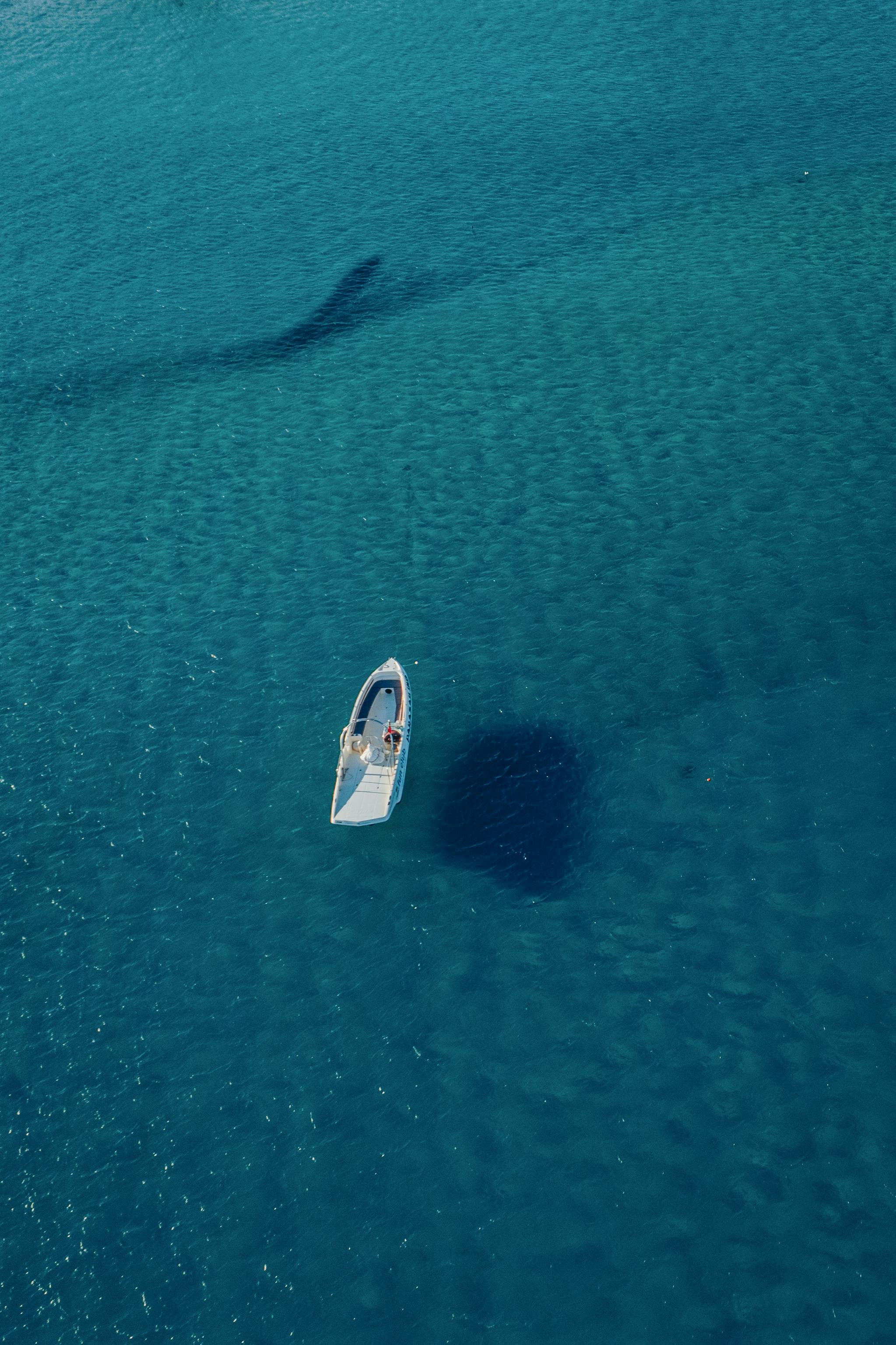 Aerial Photo of a Boat in the Middle of The Ocean · Free Stock Photo