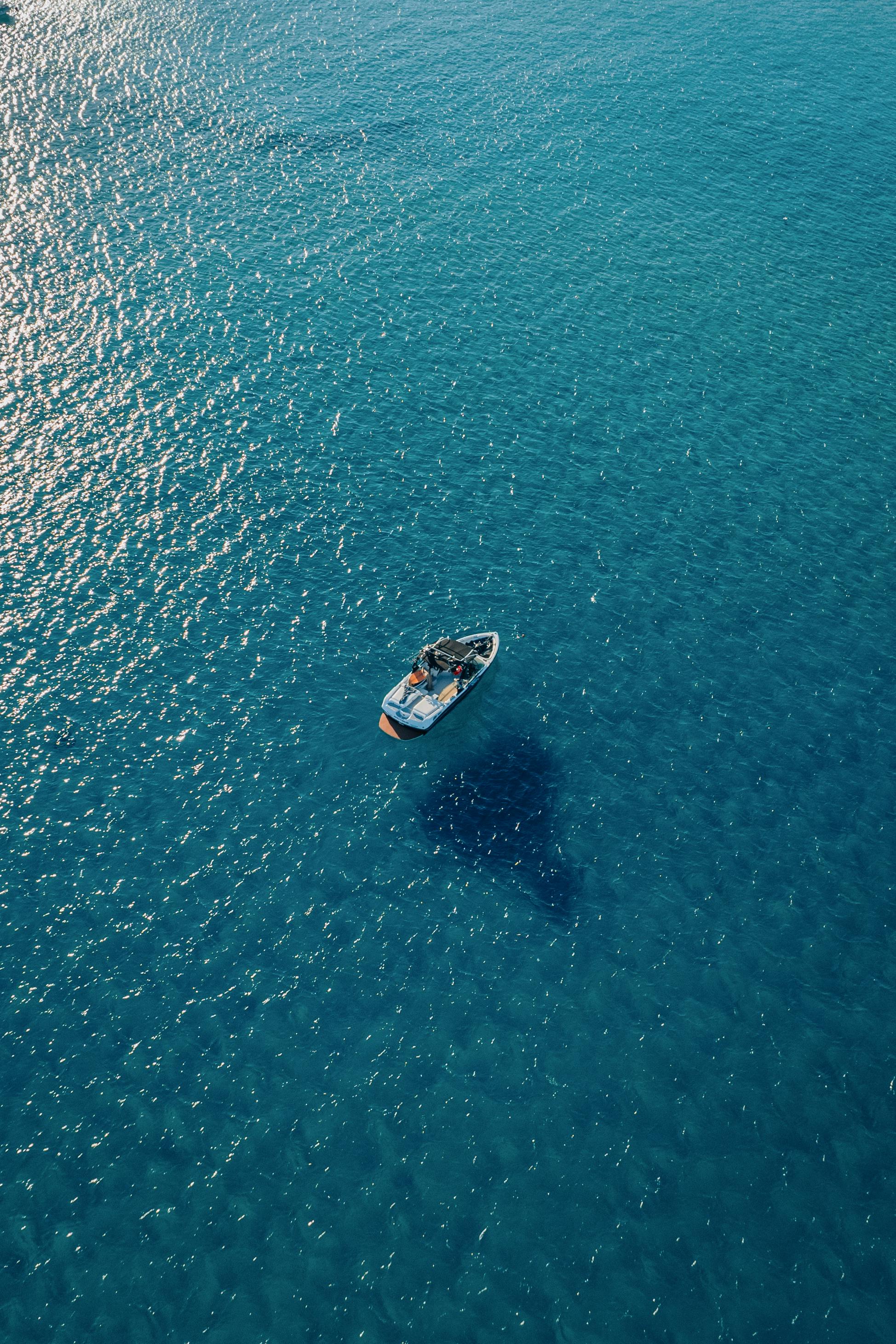 A Boat on Sea Near Rock Formations · Free Stock Photo