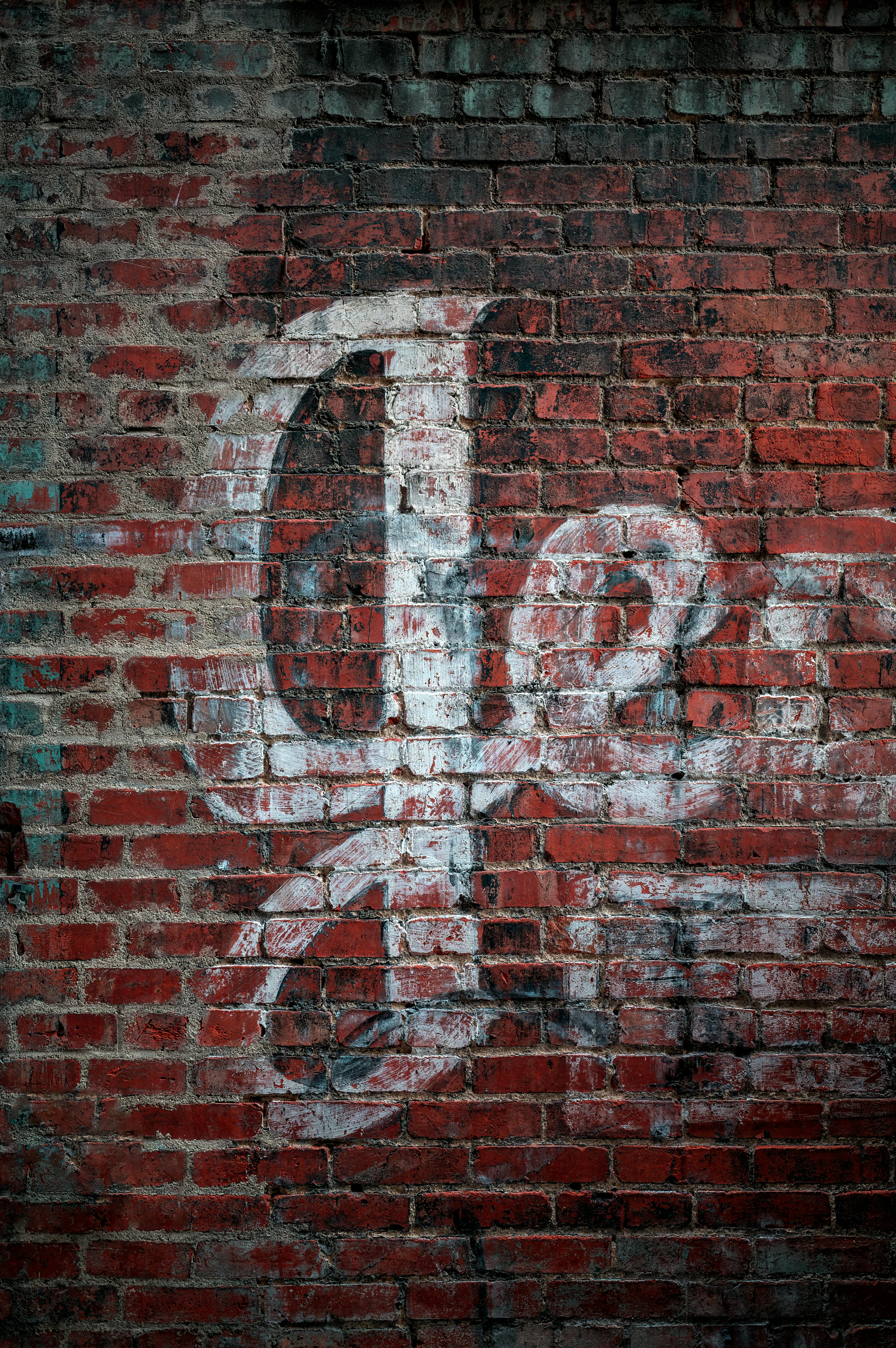 Red Brick Wall with an Old Graffiti · Free Stock Photo