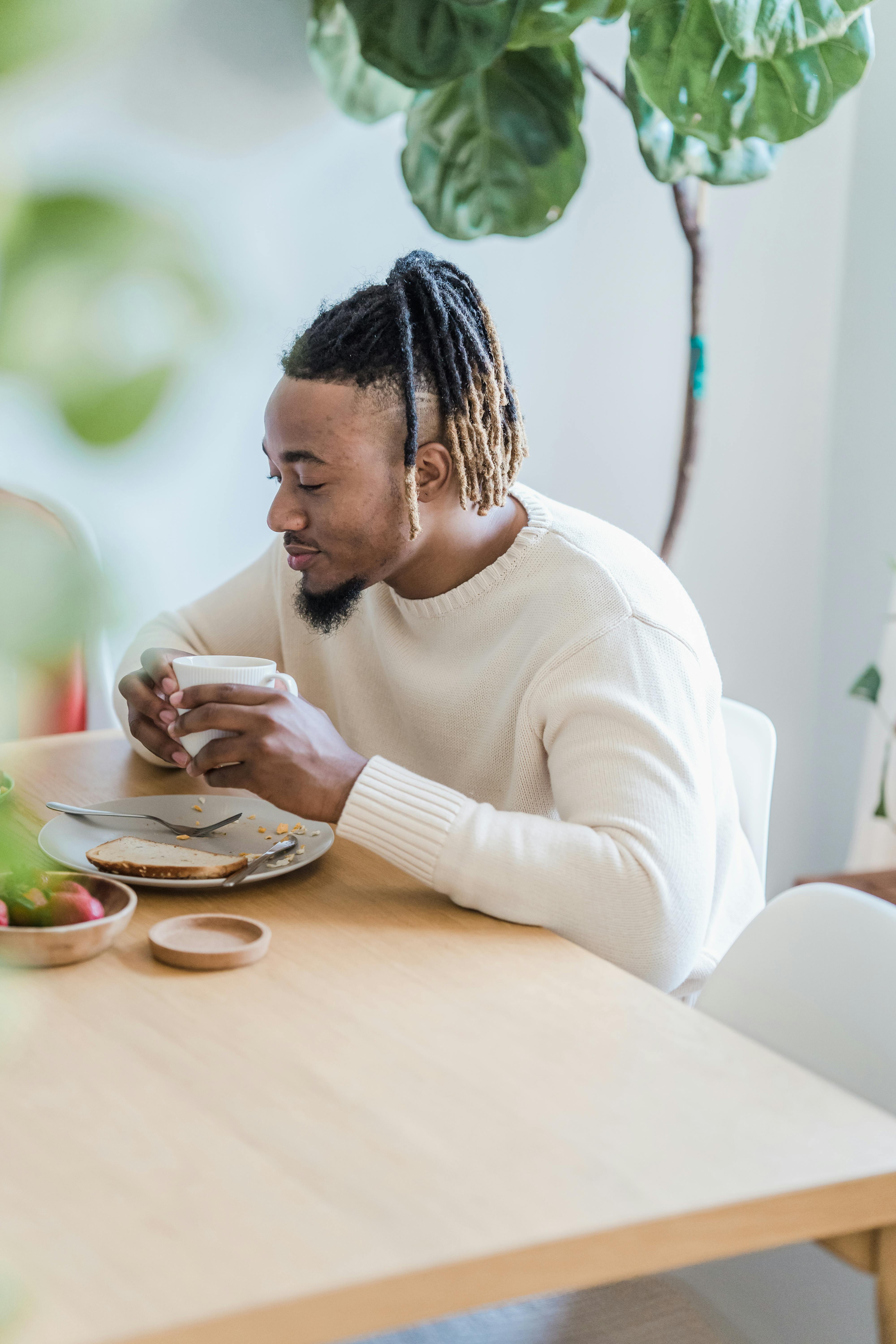 Man Sitting Behind a Table and Enjoying His Meal · Free Stock Photo