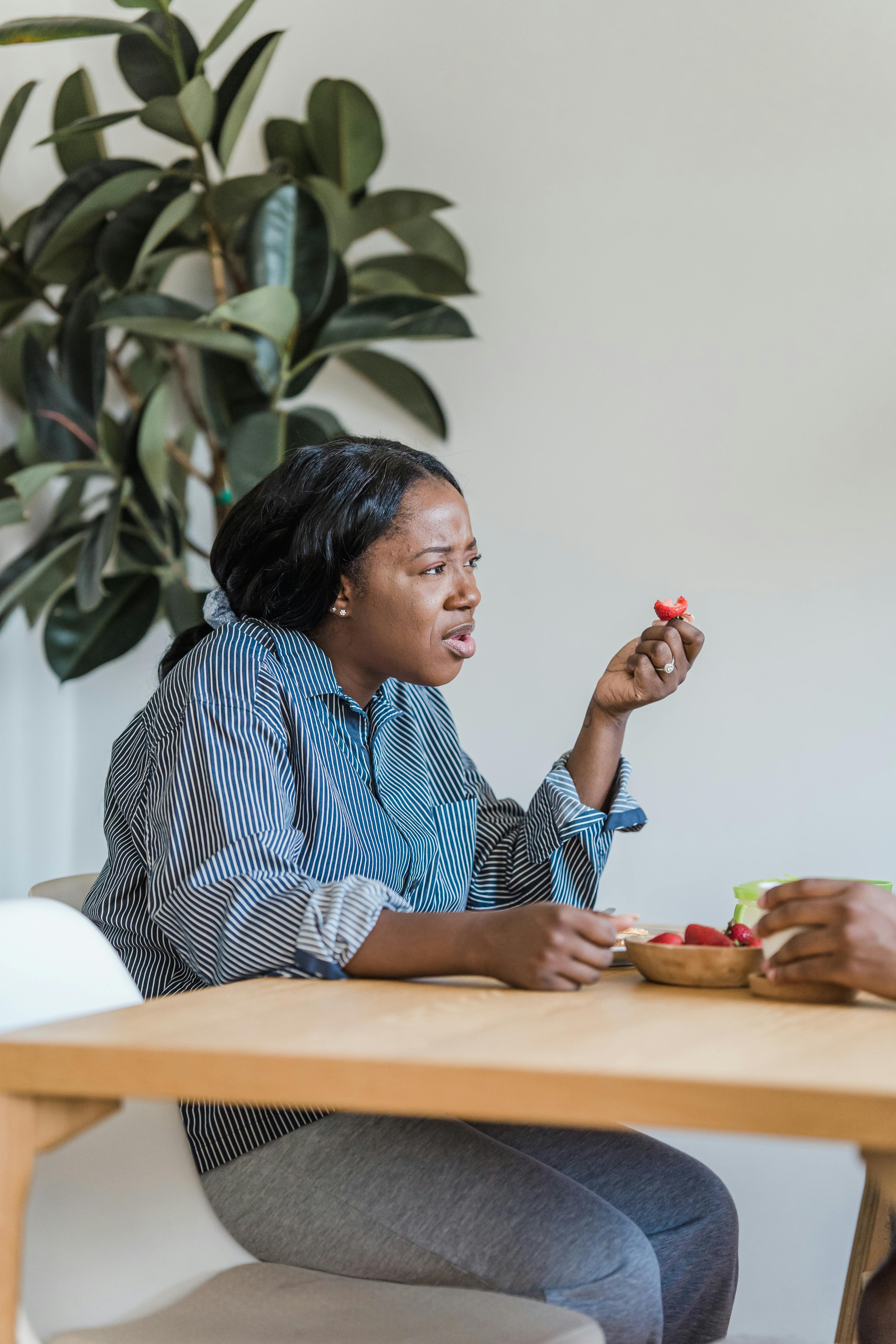 Woman Sitting Behind a Table During a Meal, Talking and Gesticulating ...