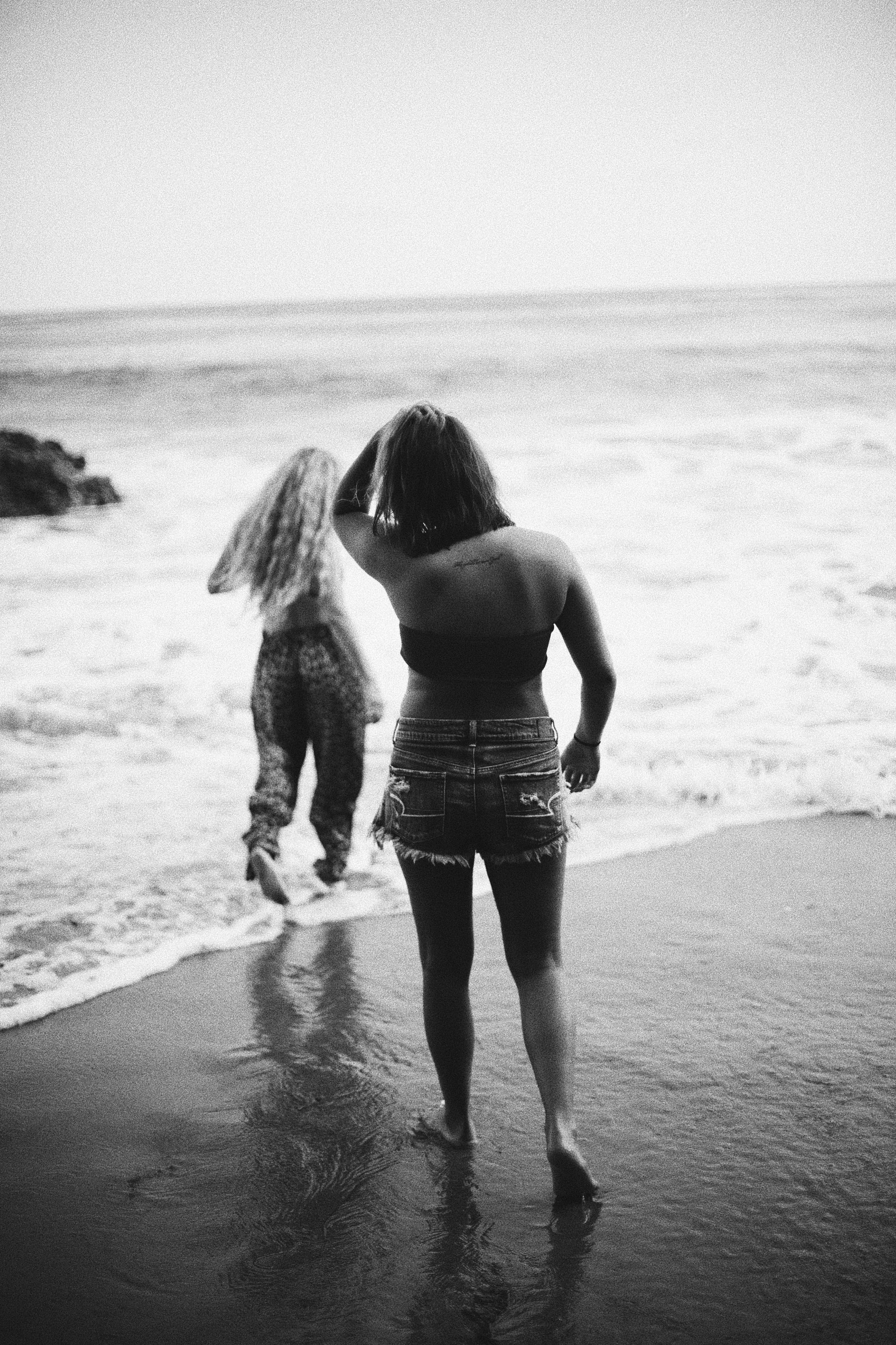 Back View of Two Women on a Beach · Free Stock Photo