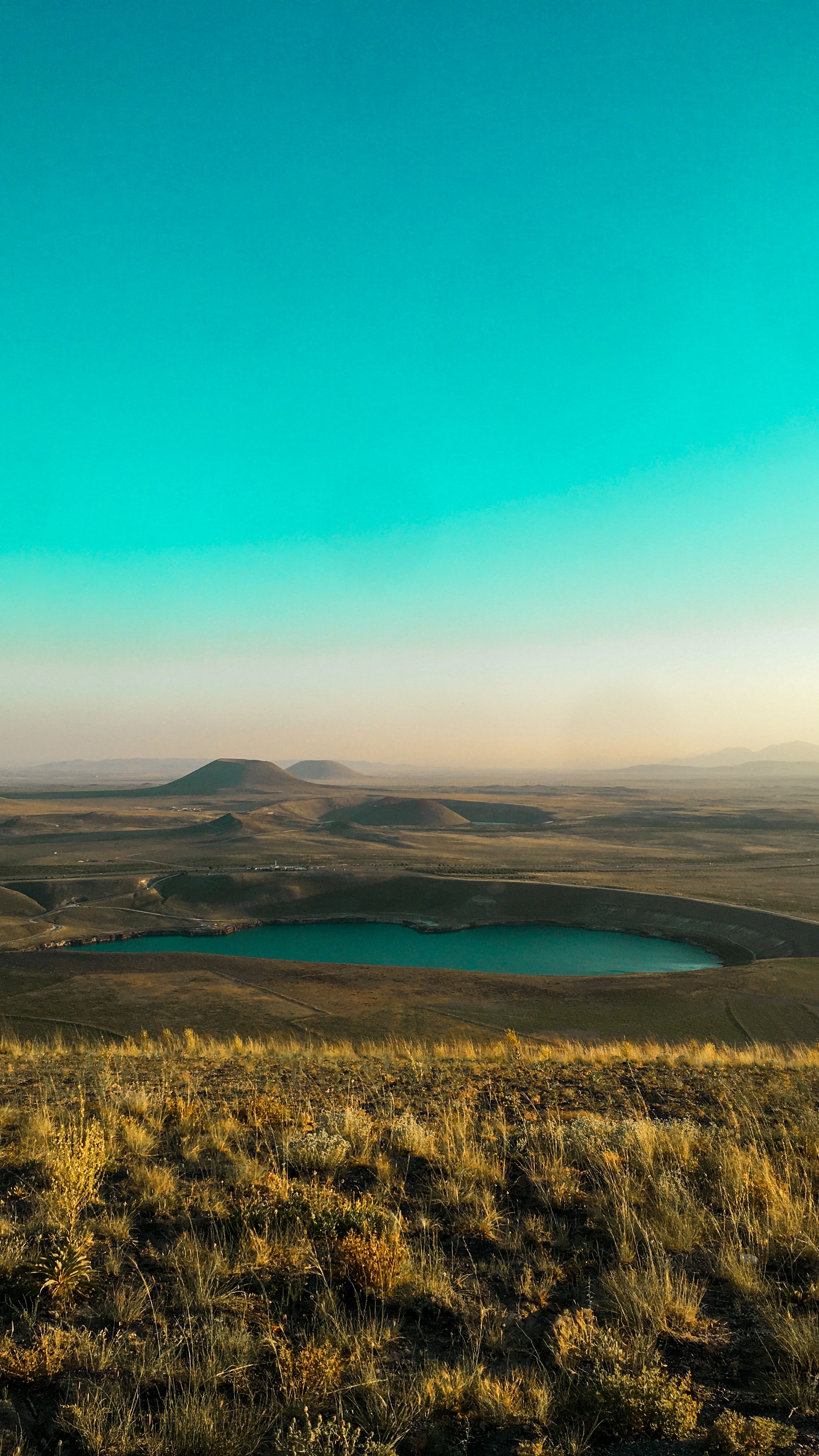 View of a Lake and Volcanoes From a Hill · Free Stock Photo